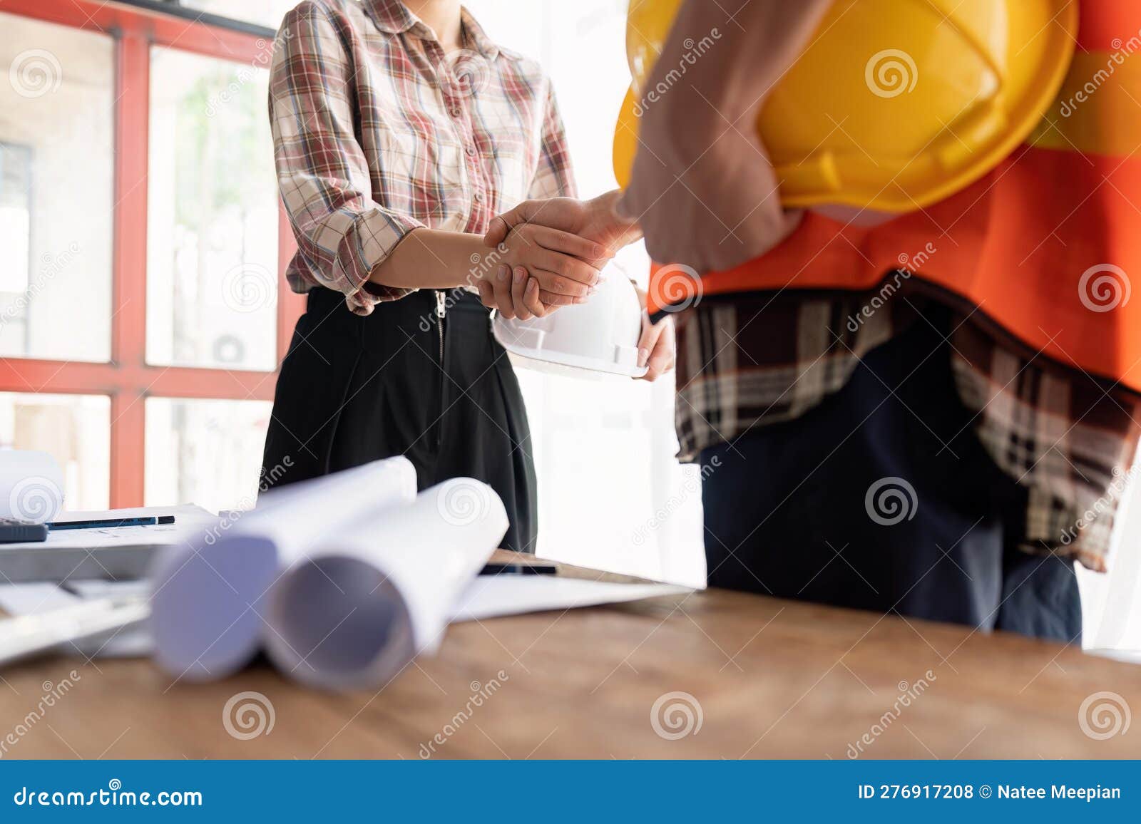 Architect and Engineer Construction Workers Shaking Hands while Working ...