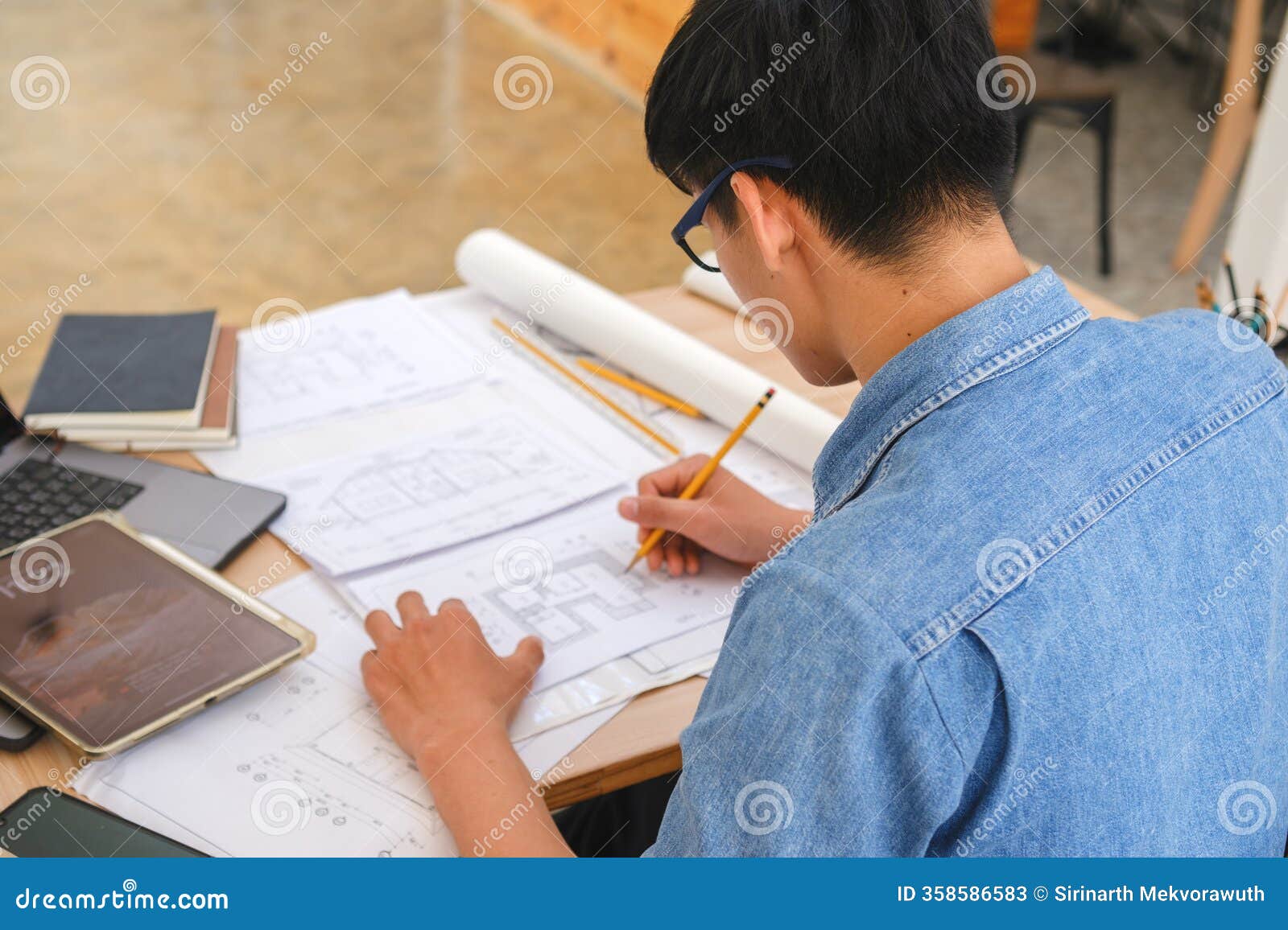 Architect and Engineer Drafting Blueprints with a Pencil and Ruler at a ...