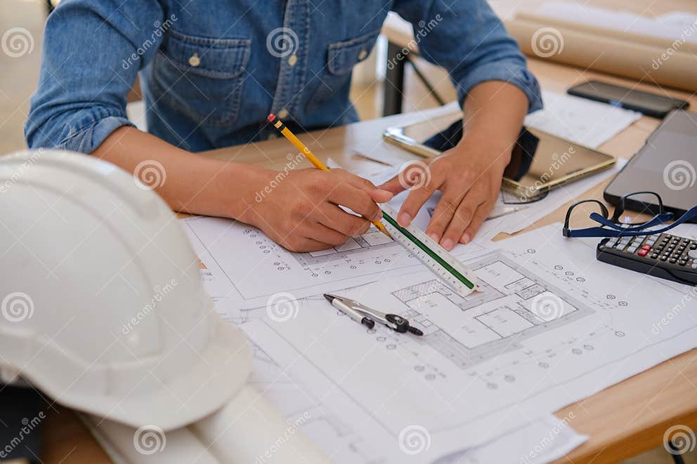 Architect and Engineer Drawing Blueprints with a Pencil and Ruler at a ...