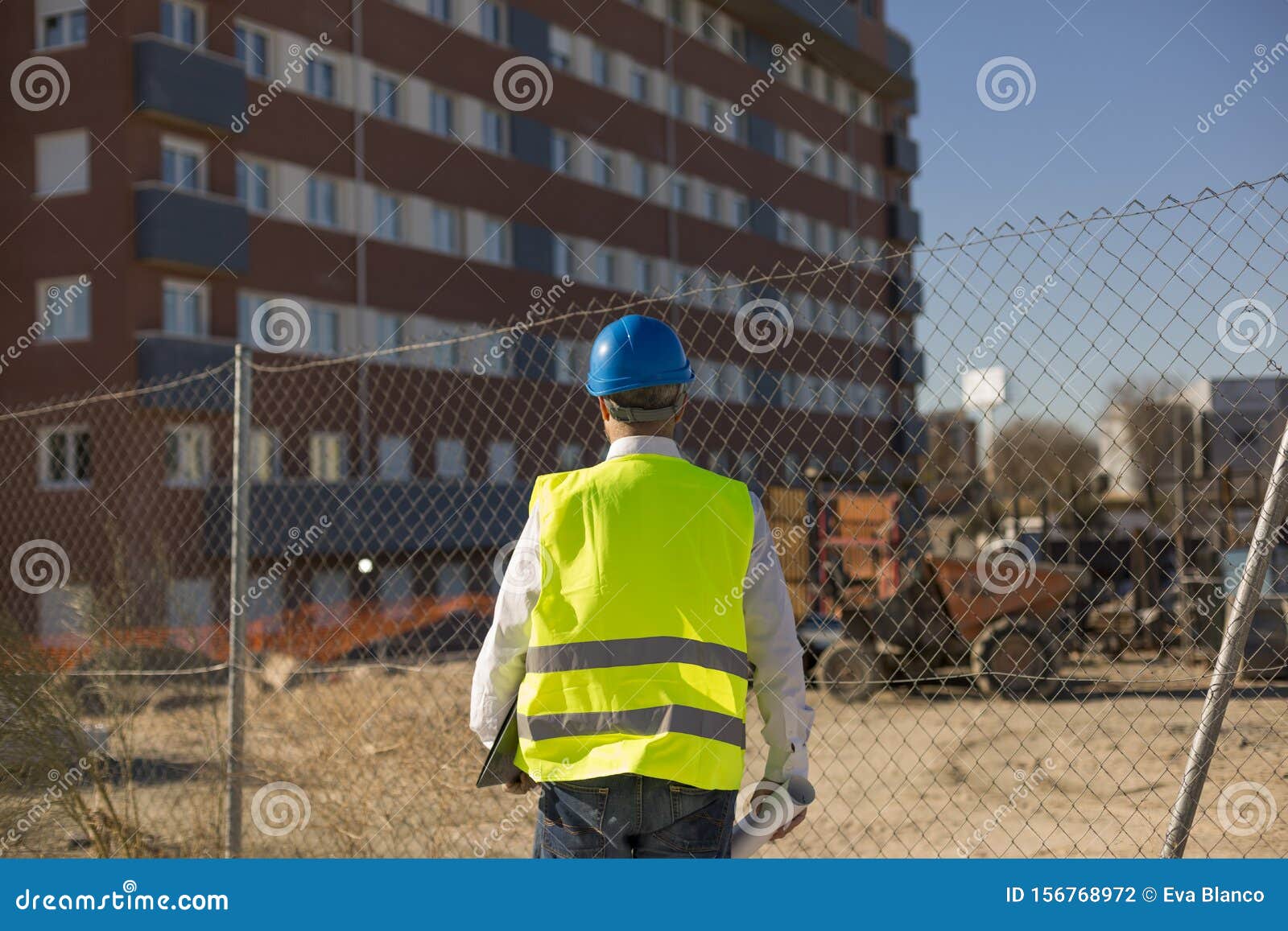 Architect Or Engineer Holding Blueprints On The Construction Sit Stock ...