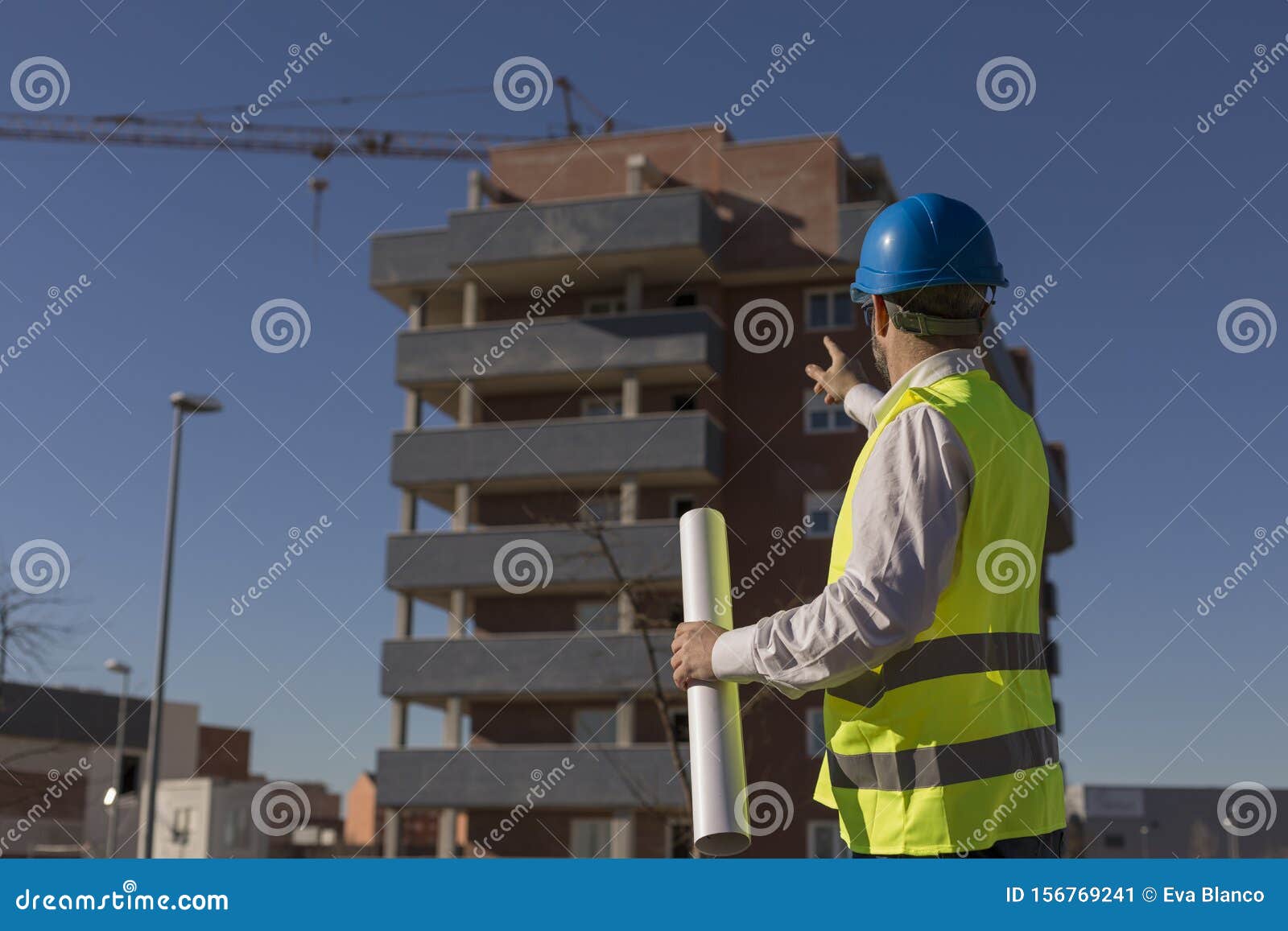 Architect or Engineer Holding Blueprints on the Construction Site ...