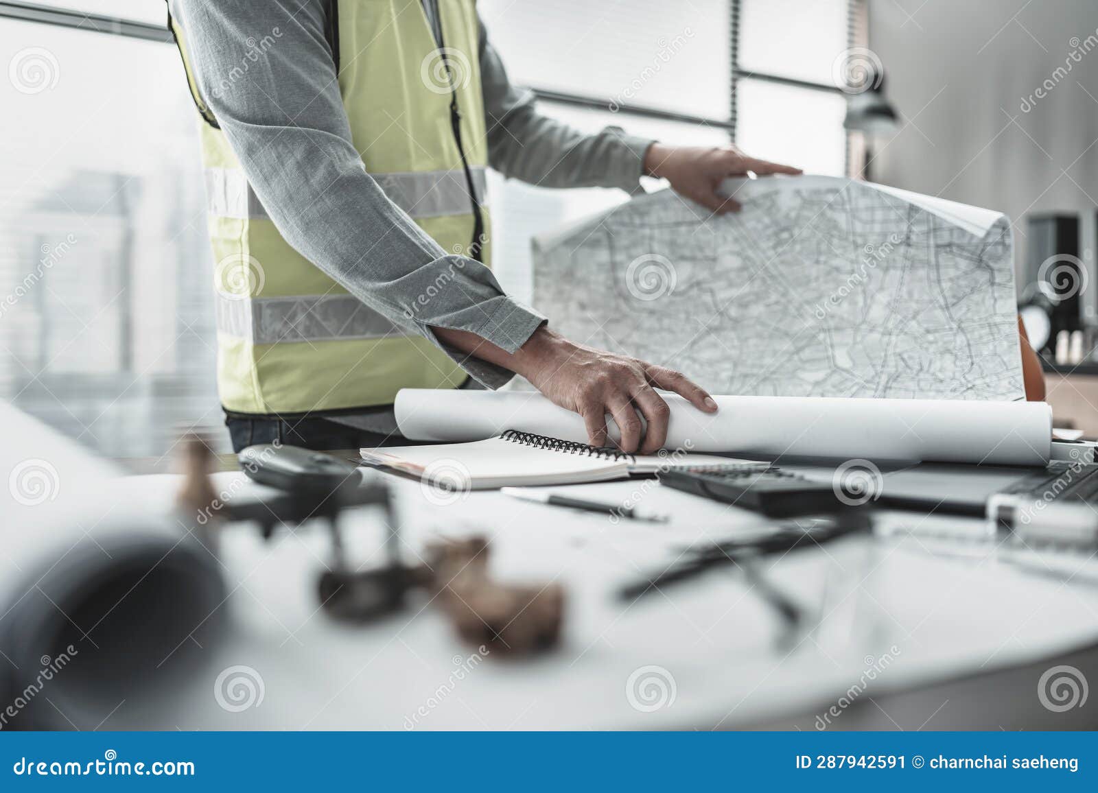 Architect, Engineer Planning and Reading on City Map and Marking a ...