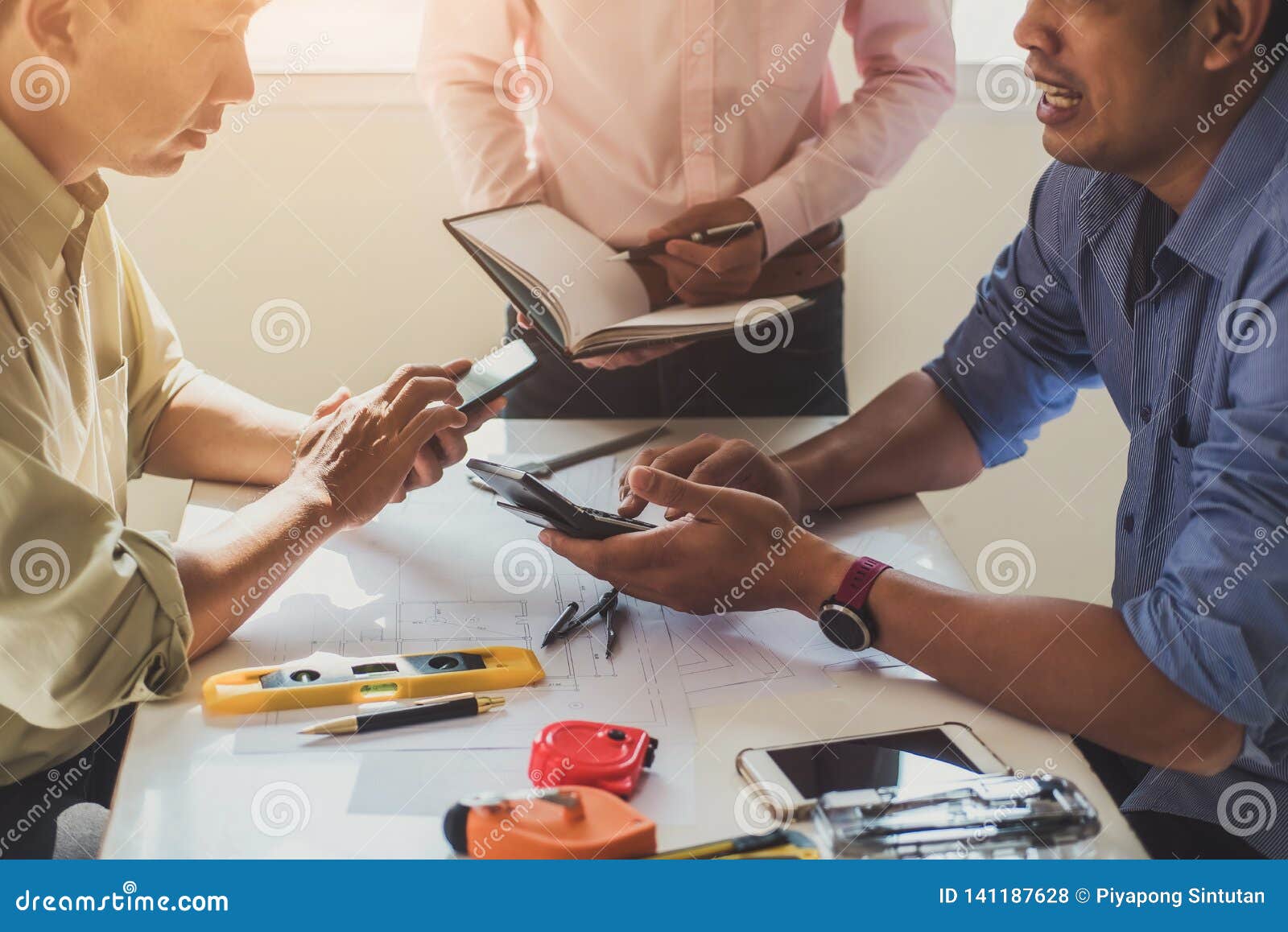 Architect or Engineer Reading Message on Phone during the Meeting ...