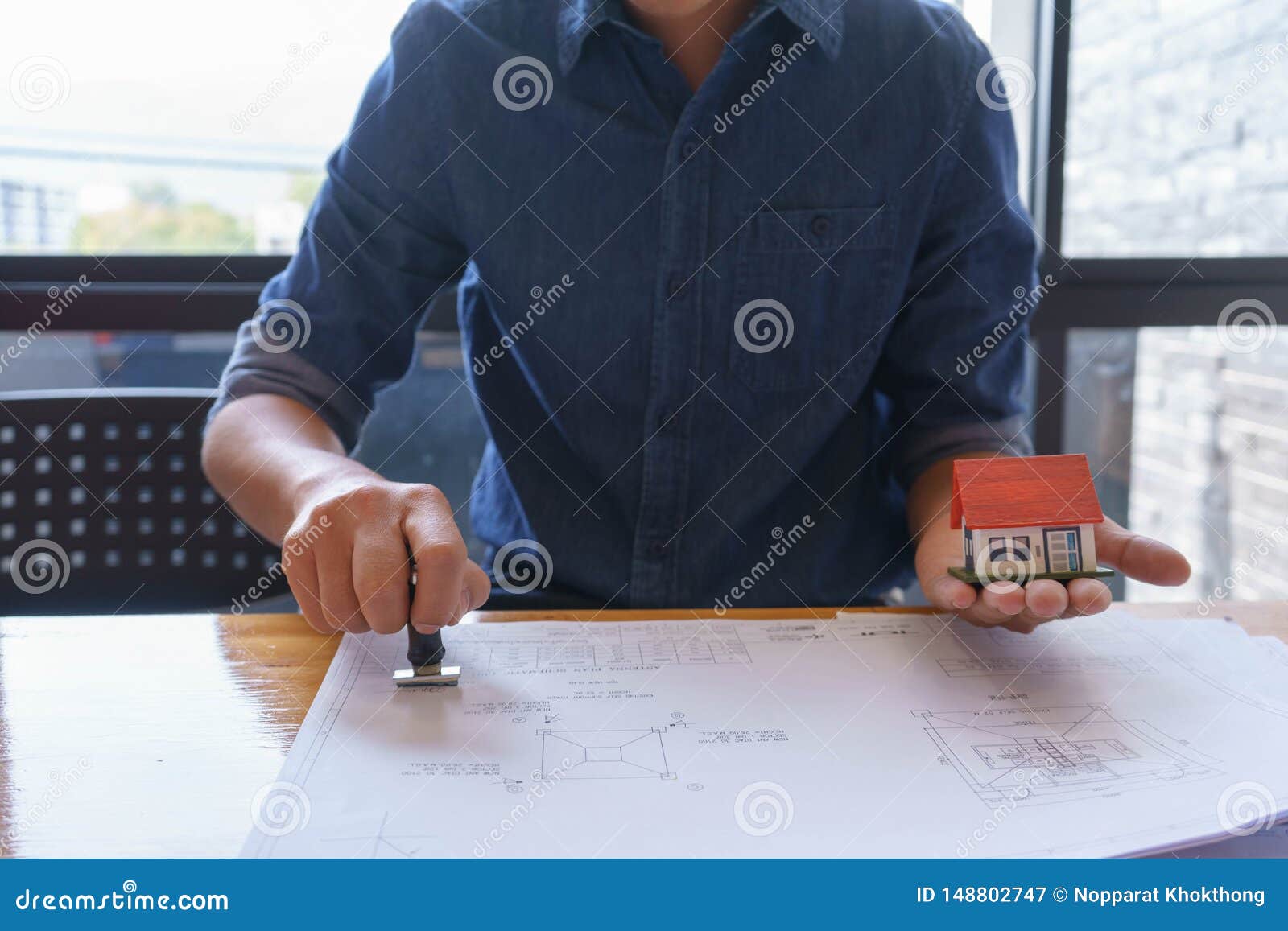 Architect or Engineer Stamping the Document or Blueprint on Wooden Desk ...
