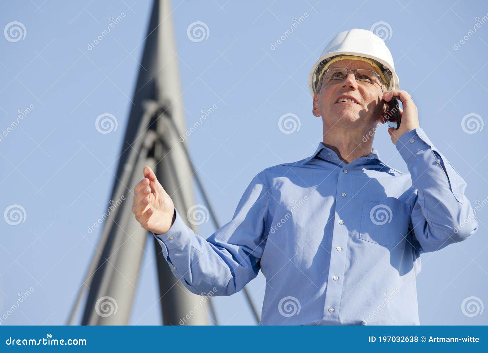Architect or Engineer Talking on Smart Phone in Front of an Industrial ...
