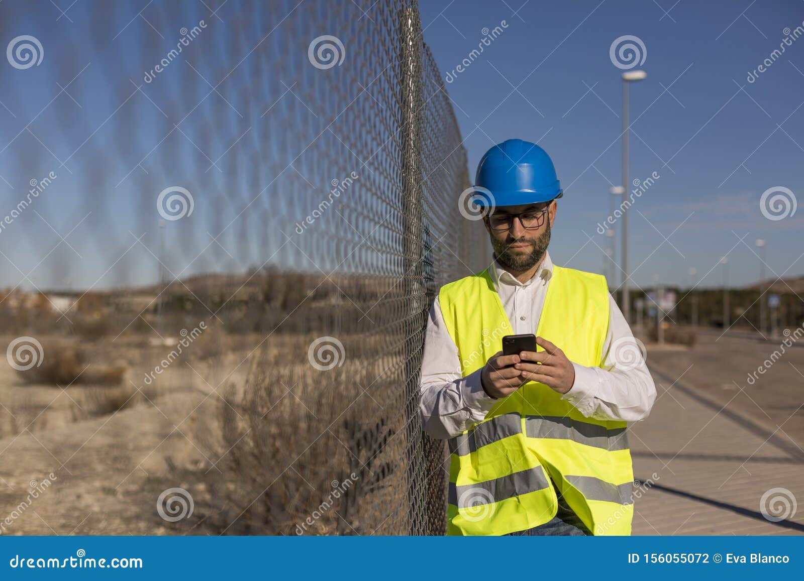 Architect or Engineer Using Cell Phone on the Construction Site Stock ...