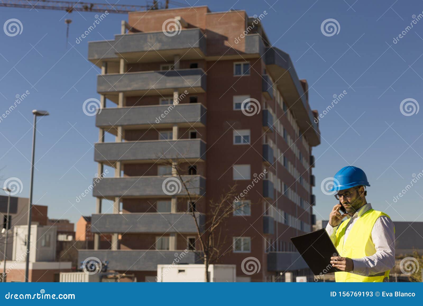 Architect or Engineer Using Cell Phone on the Construction Site Stock ...
