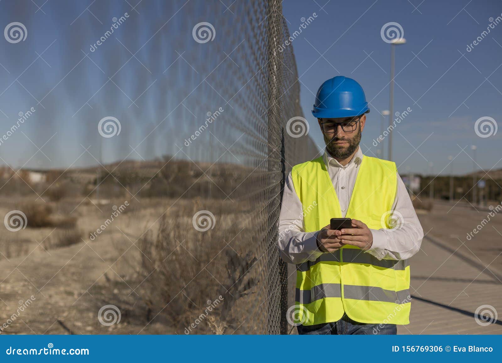Architect or Engineer Using Mobile Phone on the Construction Site ...