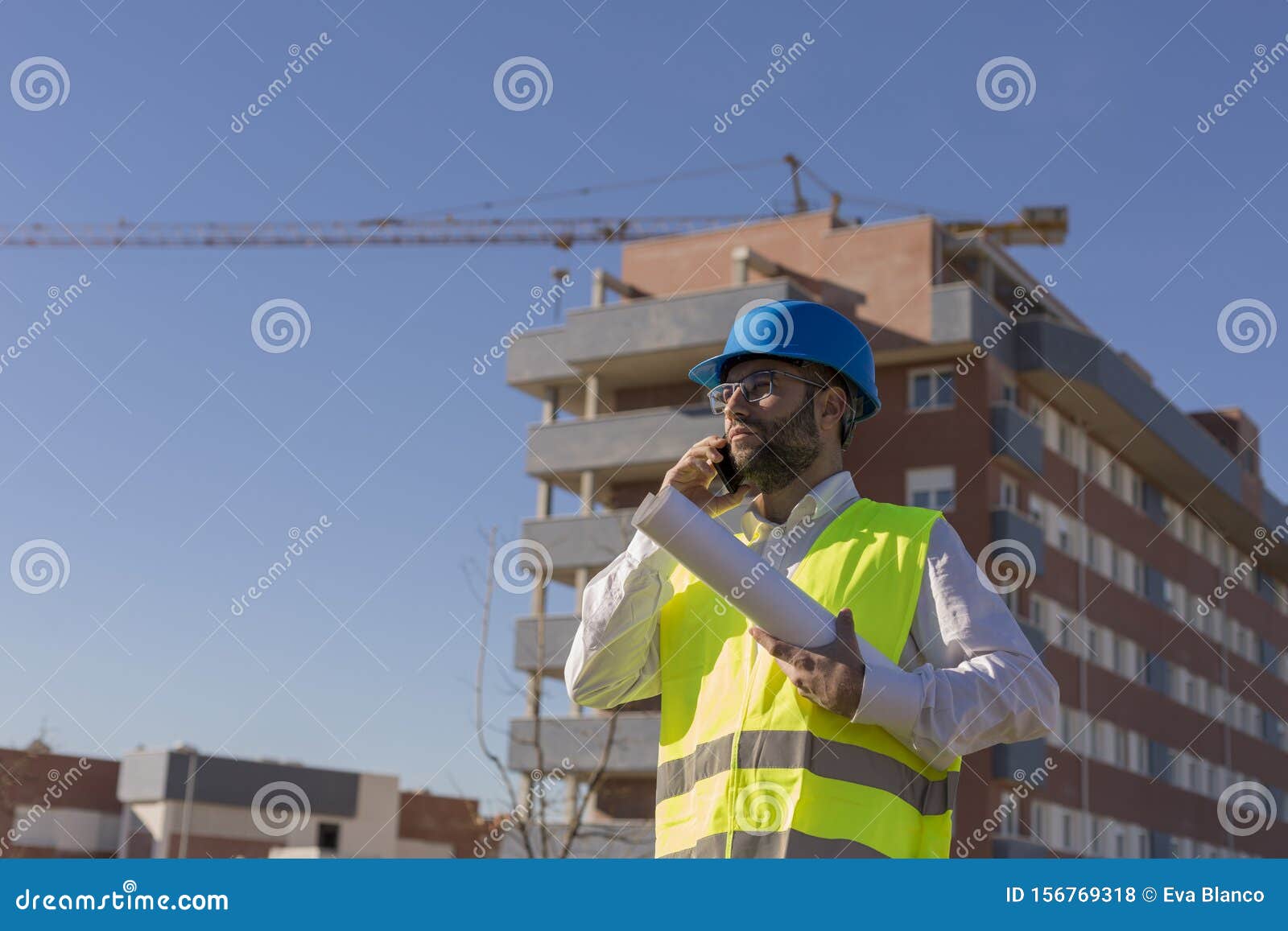 Architect or Engineer Using Mobile Phone on the Construction Site ...