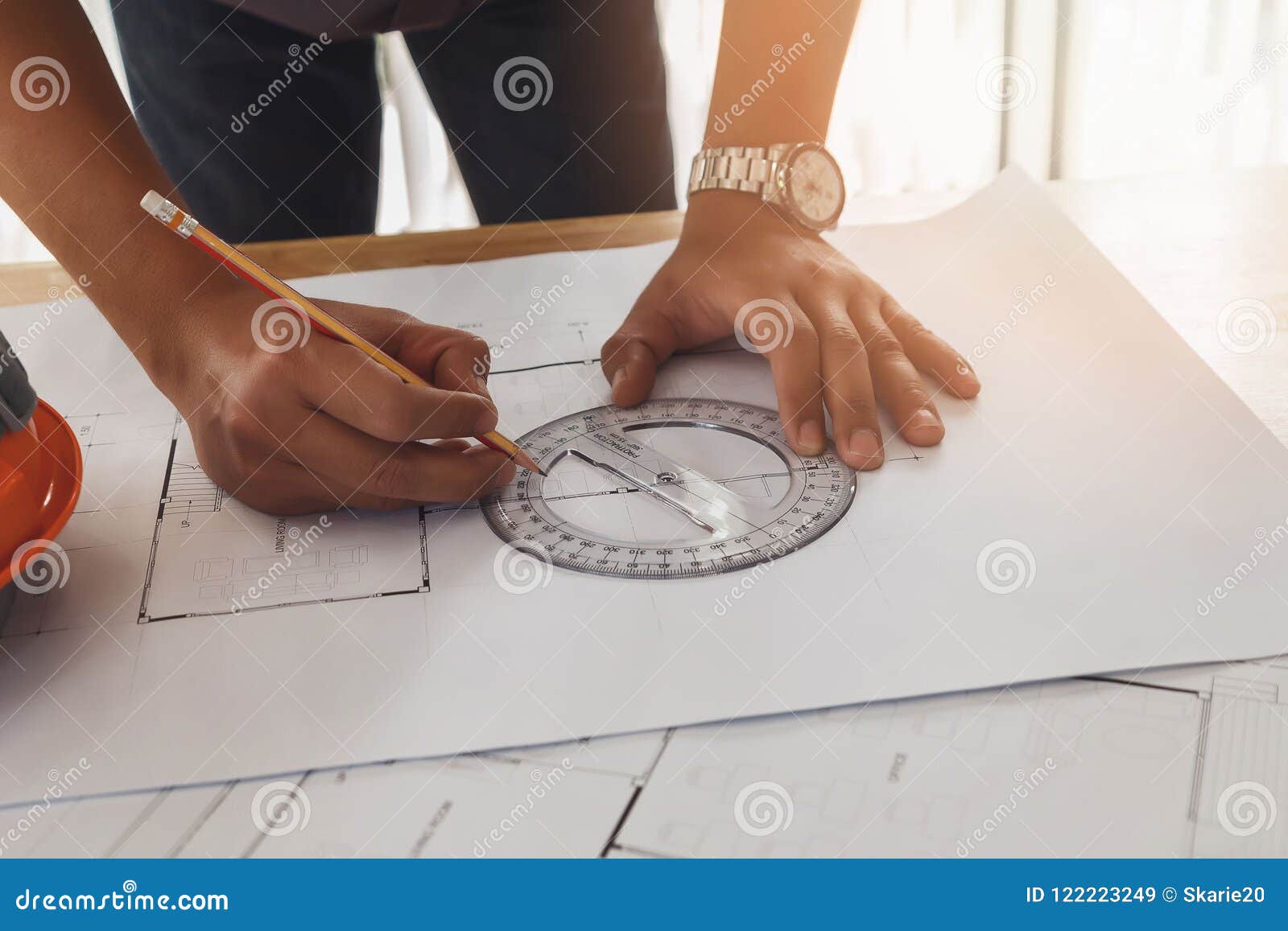 Architect or Engineer Using Pencil and Protractor Working on Blueprint ...