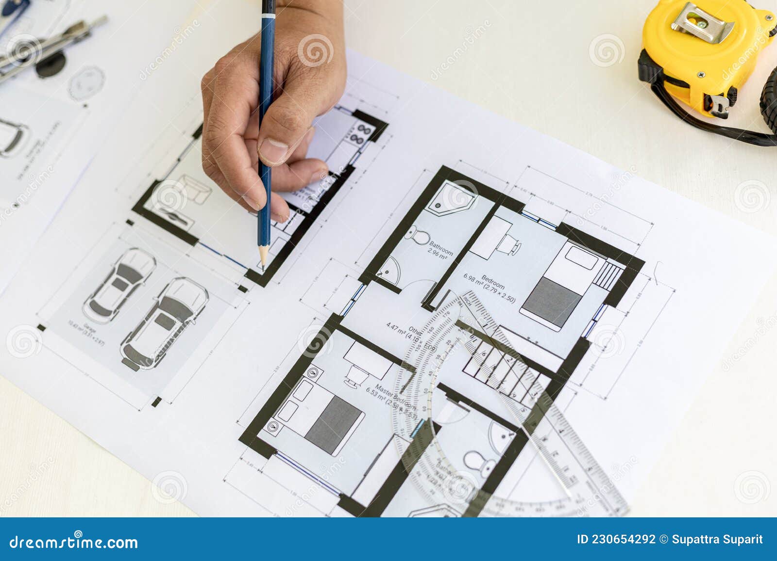 Architect Engineer Using a Pencil To Write on the Blueprints he Has ...