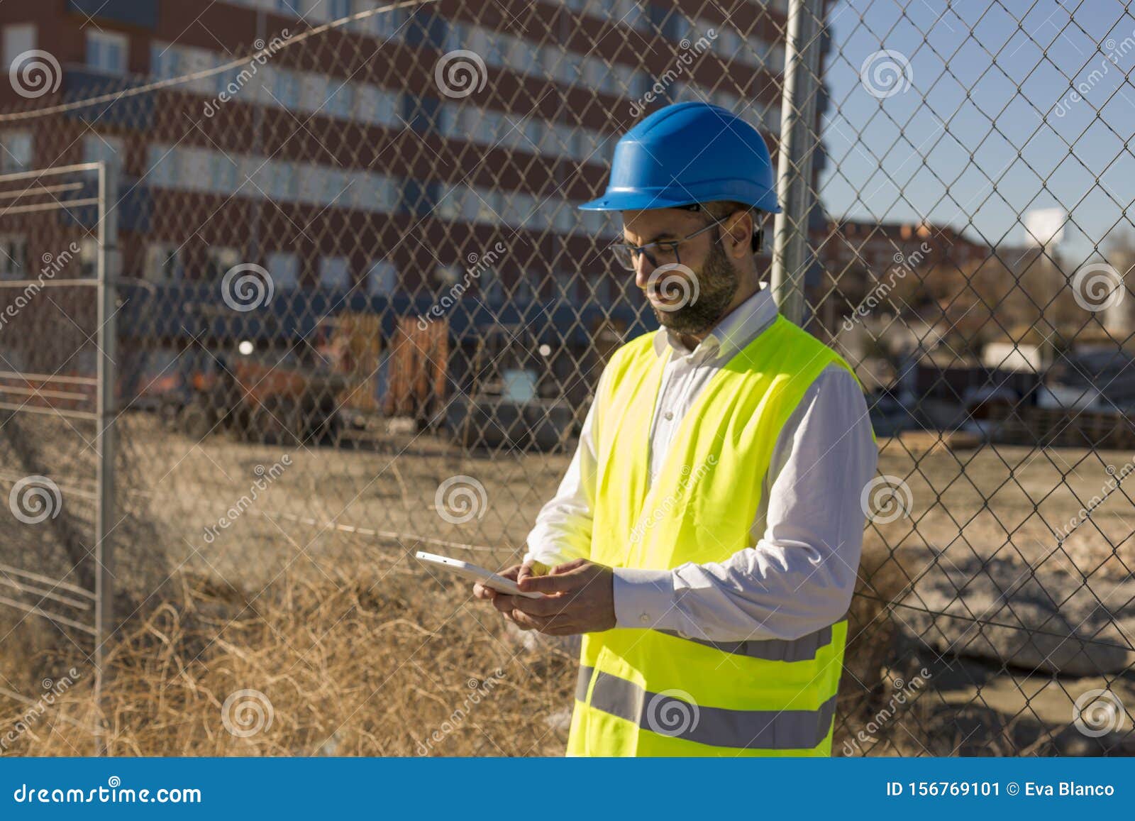Architect or Engineer Using Tablet on the Construction Site. Hol Stock ...
