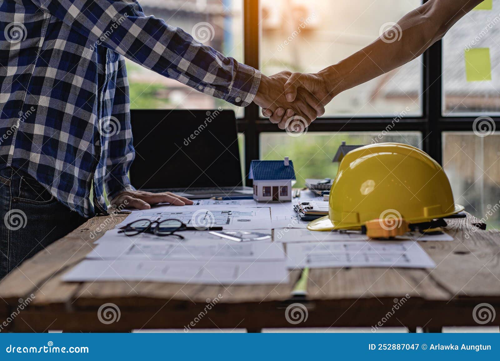 Architect Engineers Shake Hands with Hats and Houses on Construction ...
