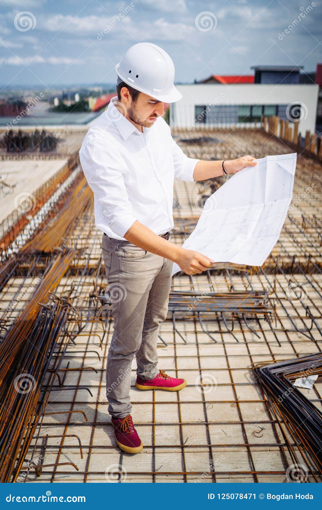 Architect Looking at Paper Plans on Construction Site. Details of ...