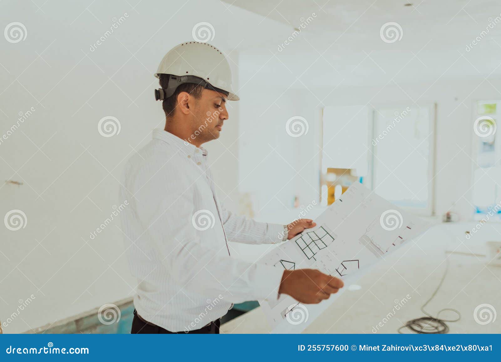 A Architect Looking at Plan and Thinking about Working on Big Project ...