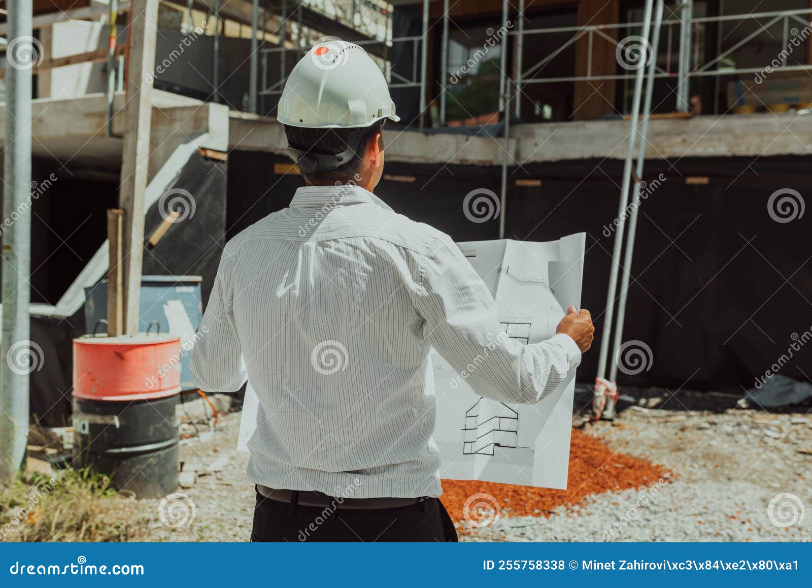 A Architect Looking at Plan and Thinking about Working on Big Project ...