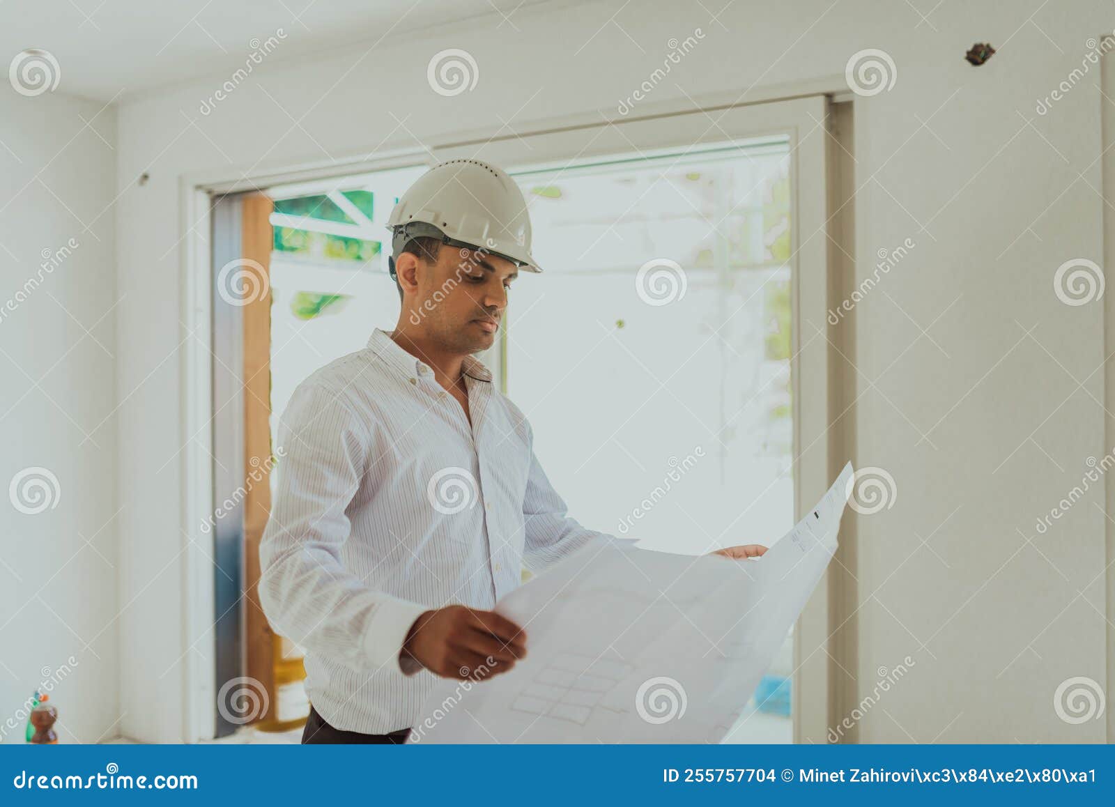 A Architect Looking at Plan and Thinking about Working on Big Project ...