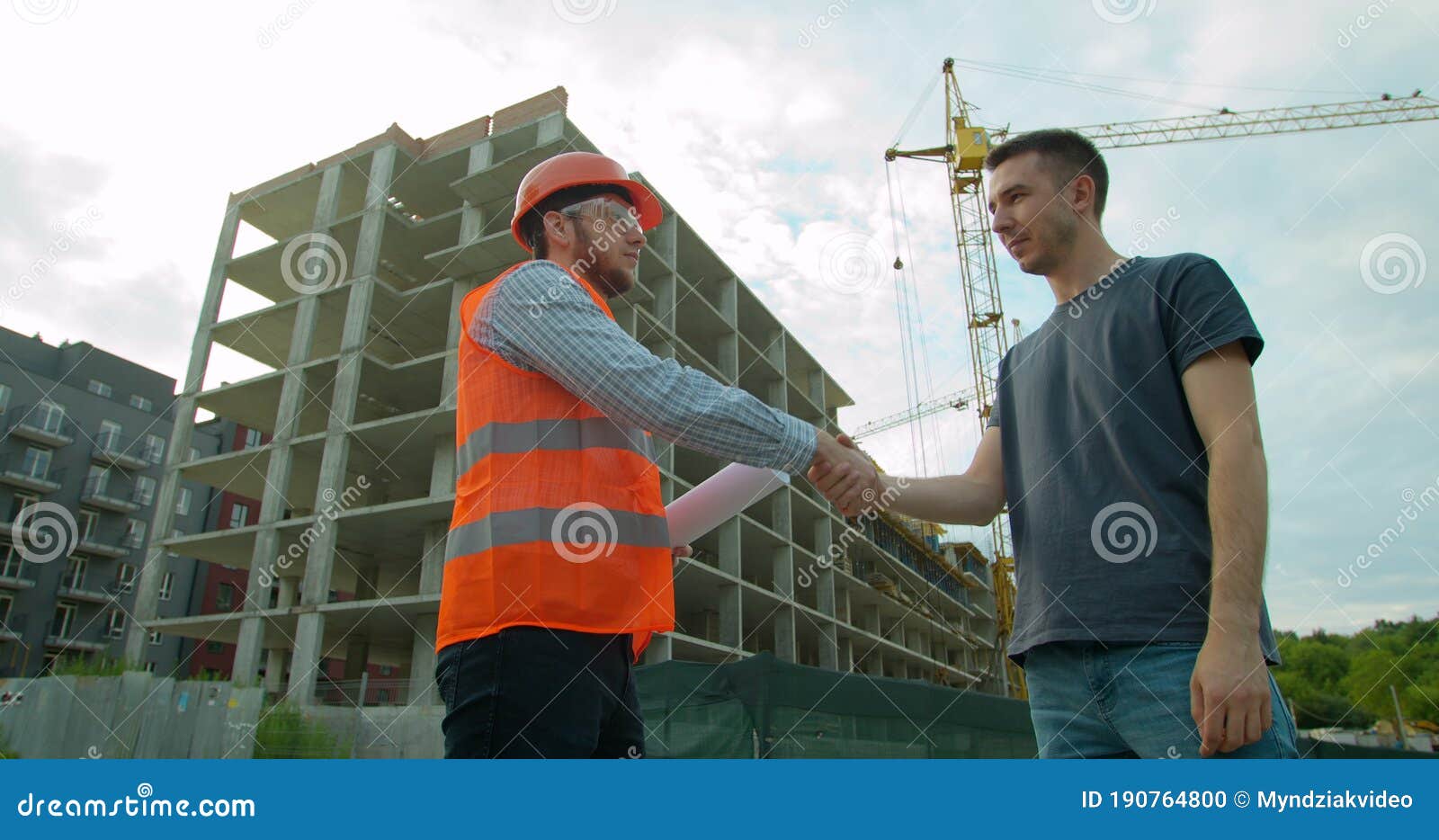 Architect and Man Engineer Shaking Hands with Blueprint at Construction ...