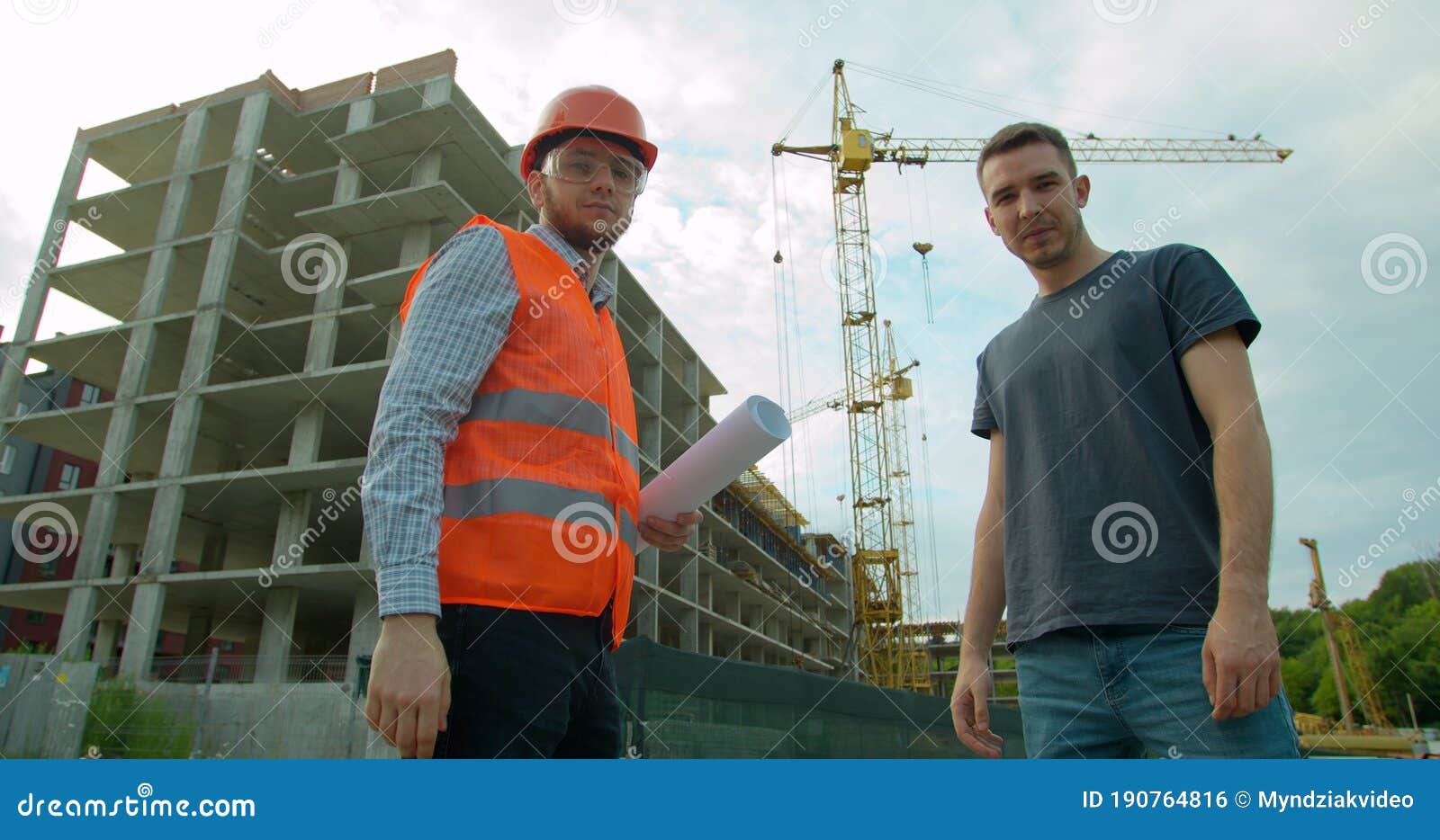 Architect and Man Engineer Shaking Hands with Blueprint at Construction ...