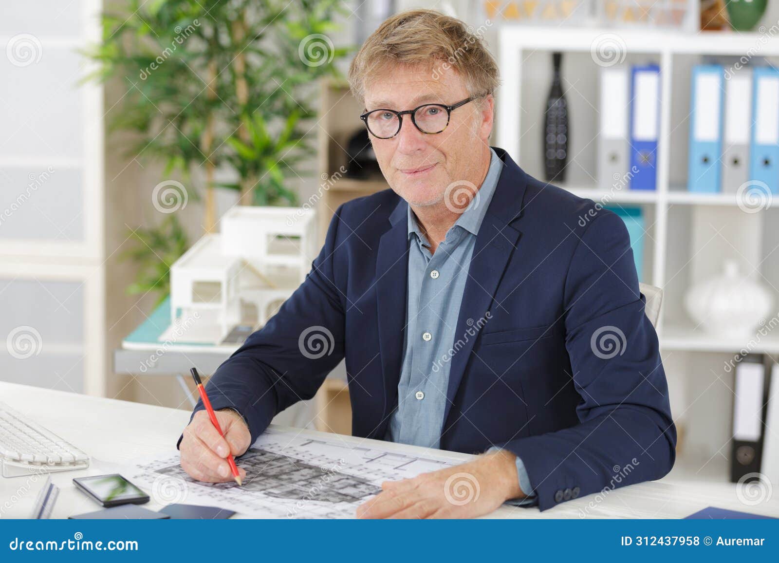 Architect in Office Sitting on Desk Looking at Camera Stock Photo ...