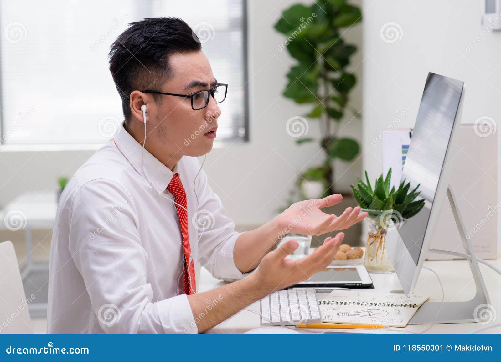 Architect in Office Talking To Client on Phone with Earphones Stock ...