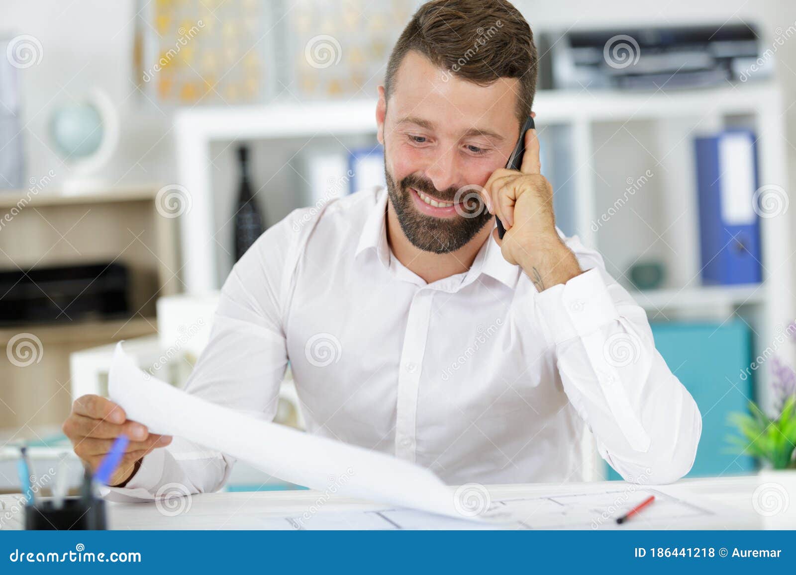 Architect in Office Talking To Client with Smartphone Stock Photo ...