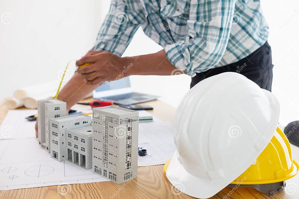 Architect is Preparing House Model and Construction Plans on Blueprints for Construction ...