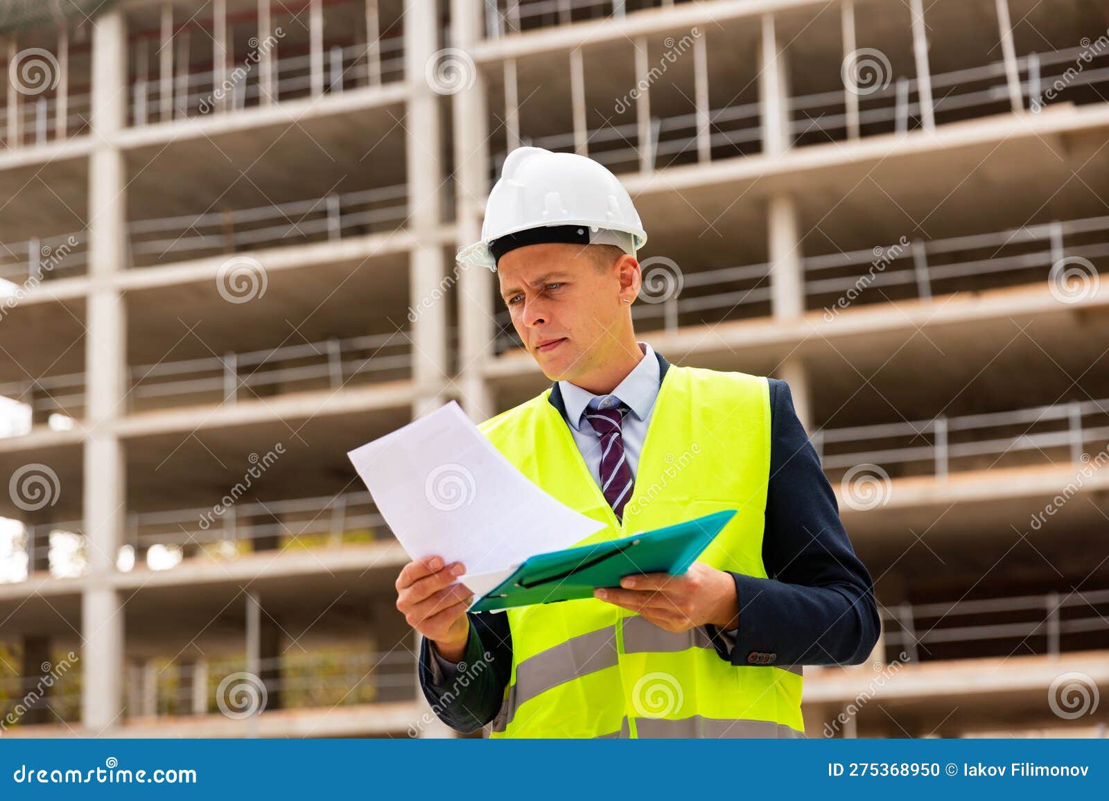 Architect in Protective Helmet and Jacket with Folder of Documents on ...