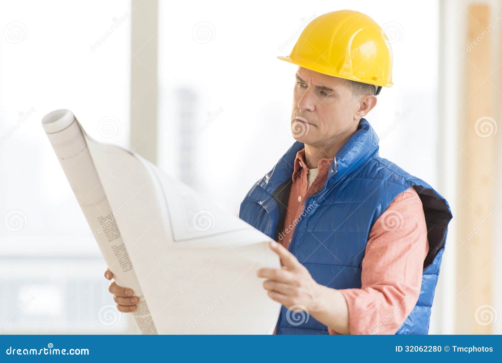 Architect Reading Blueprint at Construction Site Stock Photo - Image of ...