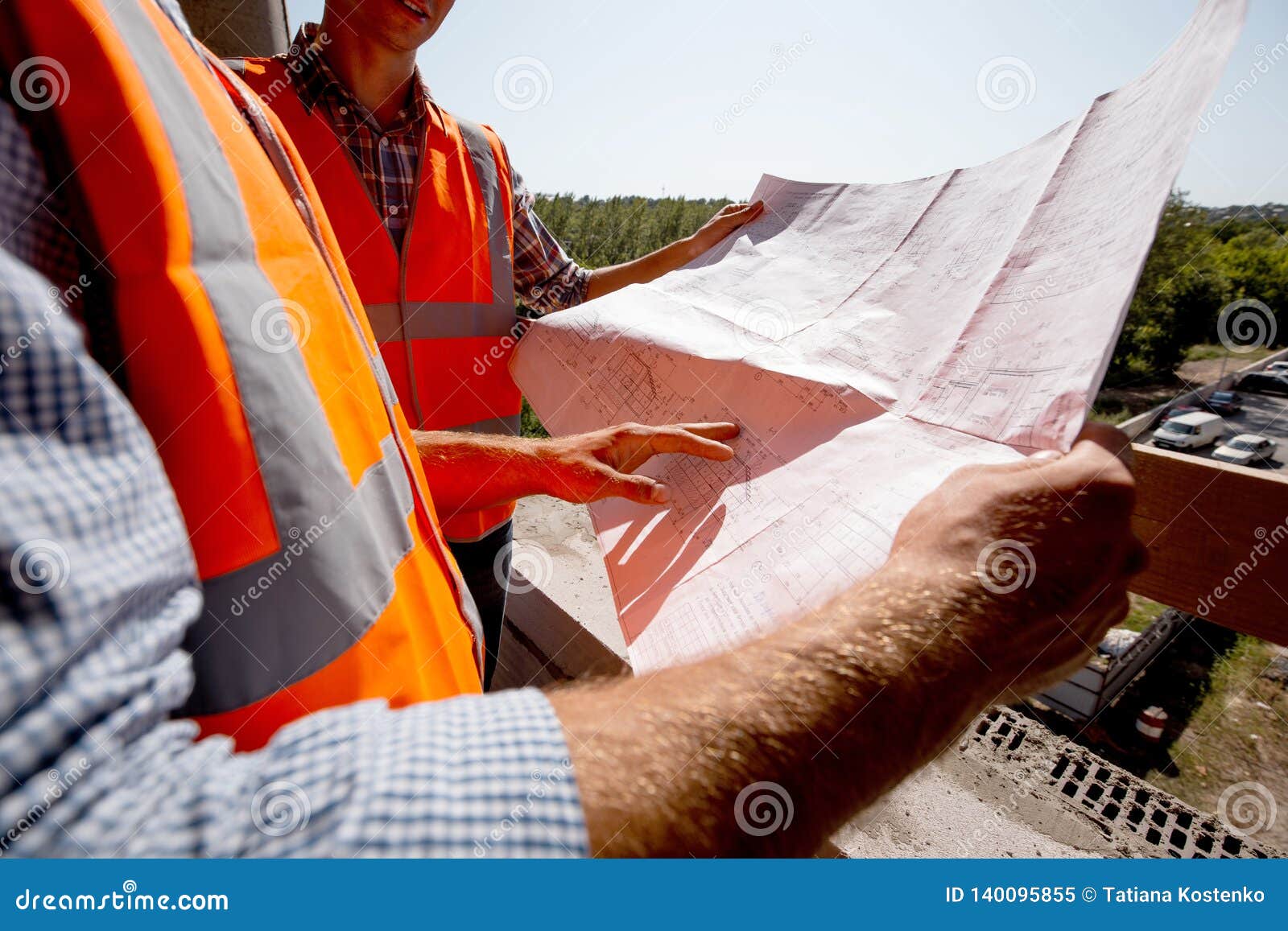 Architect and Structural Engineer Dressed in Shirts, Orange Work Vests ...