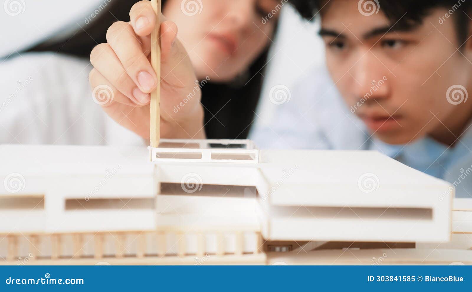 Architect Team Using Pencil To Test House Model Durability. Closeup ...