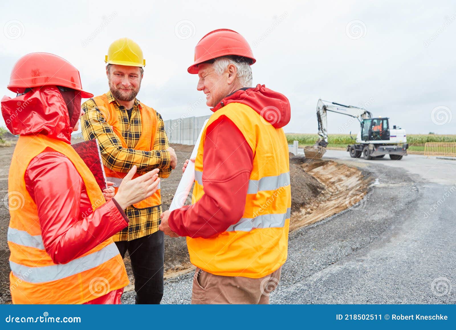 Architect and Two Construction Workers Discuss Road Construction Stock ...