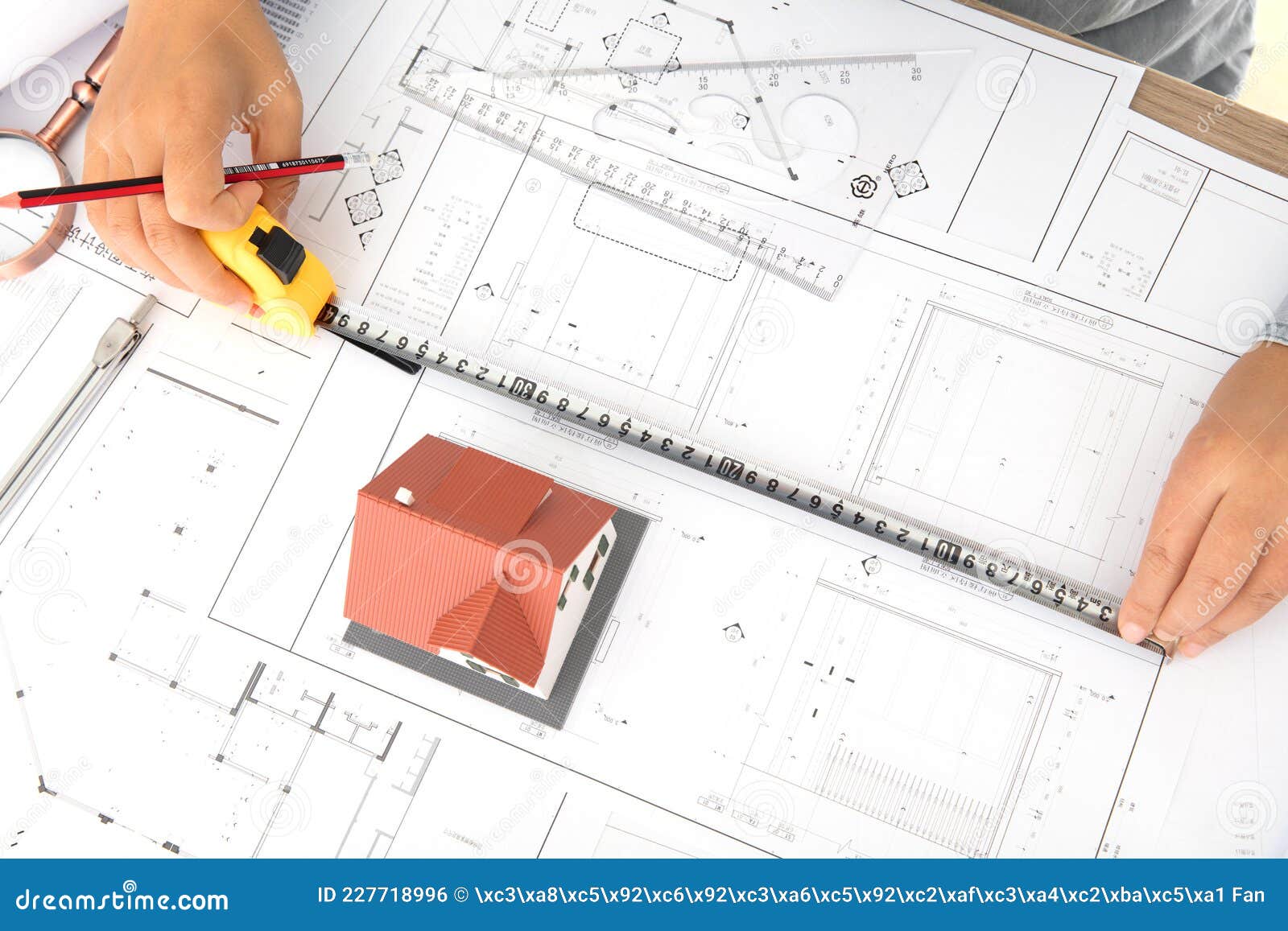 Architect Uses A Ruler To Measure The Blueprints Of The Houses He ...