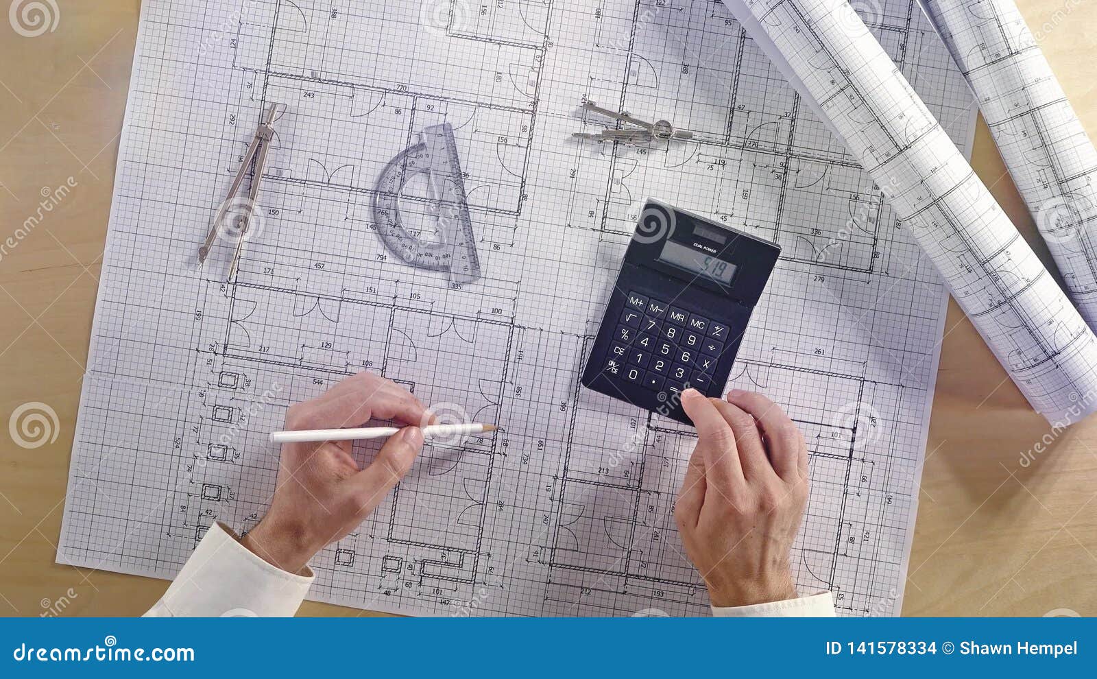 Architect Using Calculator on Architectural Blueprint House Building ...