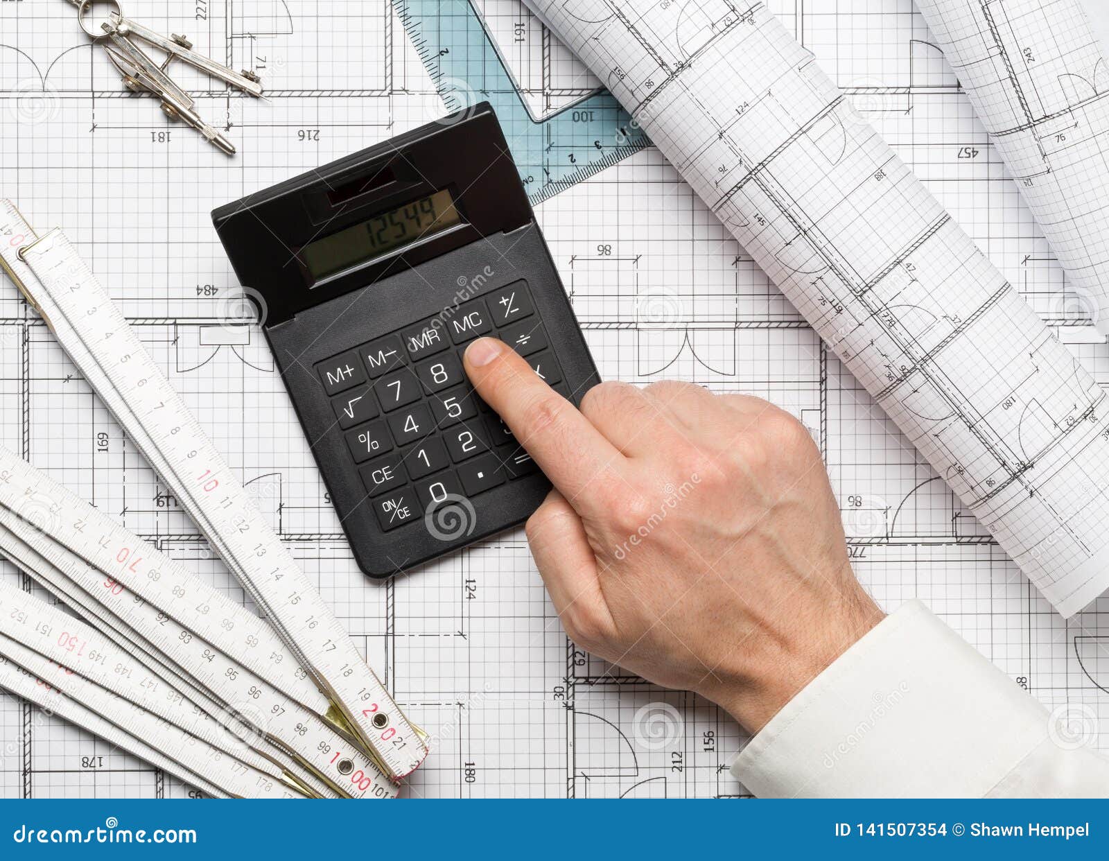 Architect Using Calculator on Architectural Blueprint House Building ...