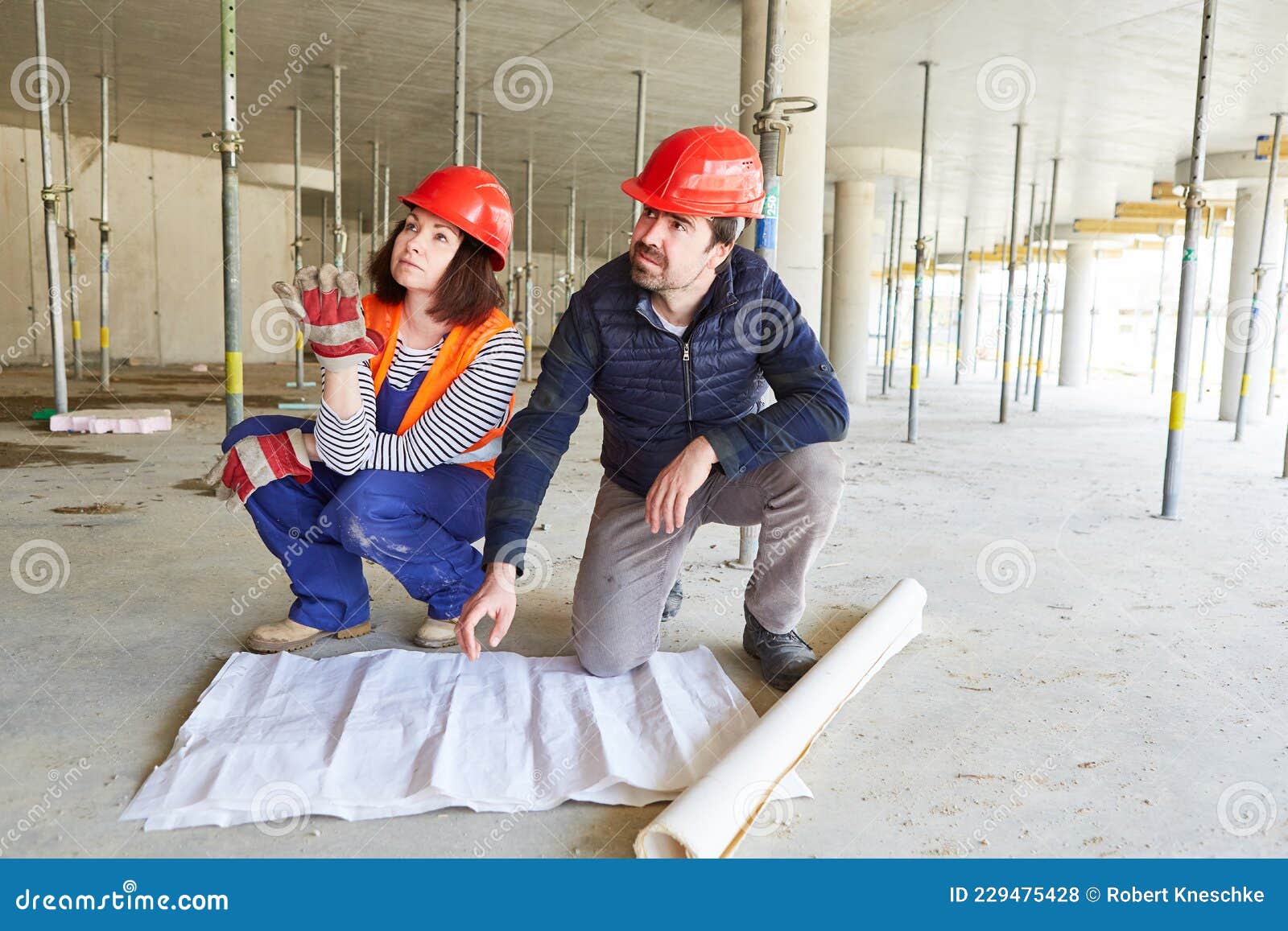 Architect and Worker with Architectural Drawing in the Shell Stock ...