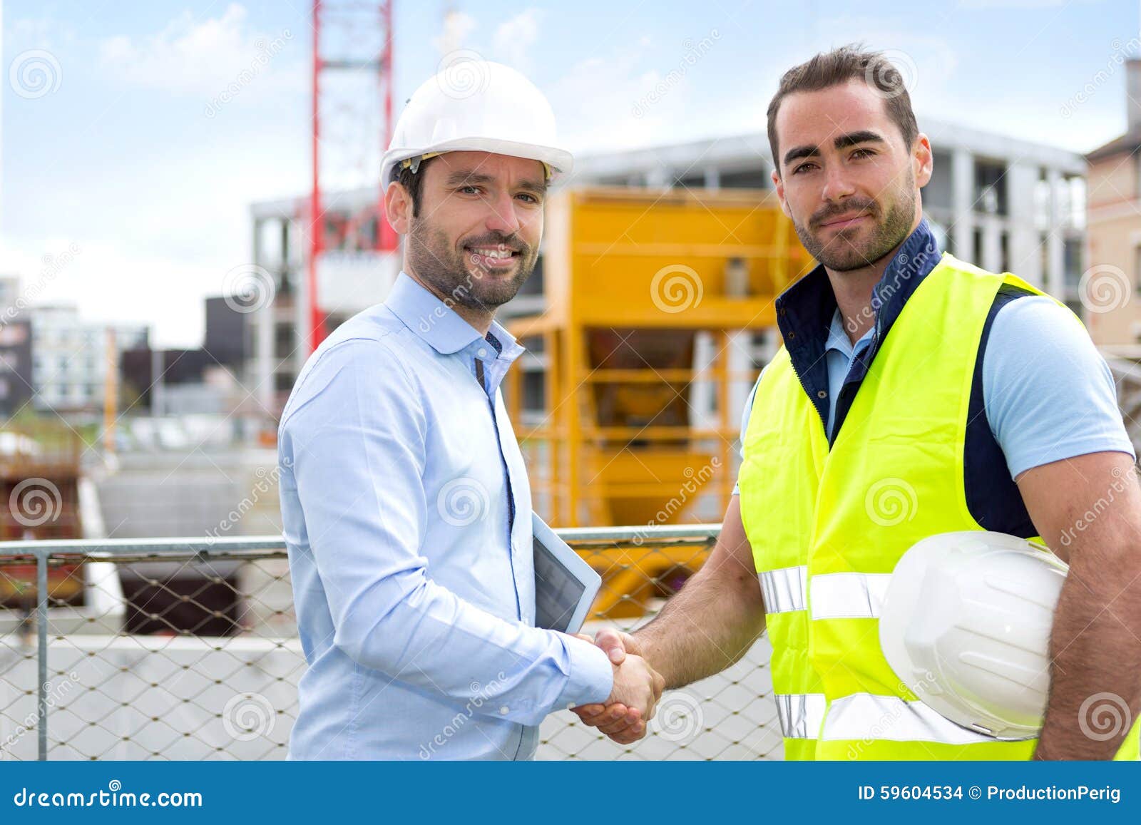 Architect and Worker Handshaking on Construction Site Stock Photo ...