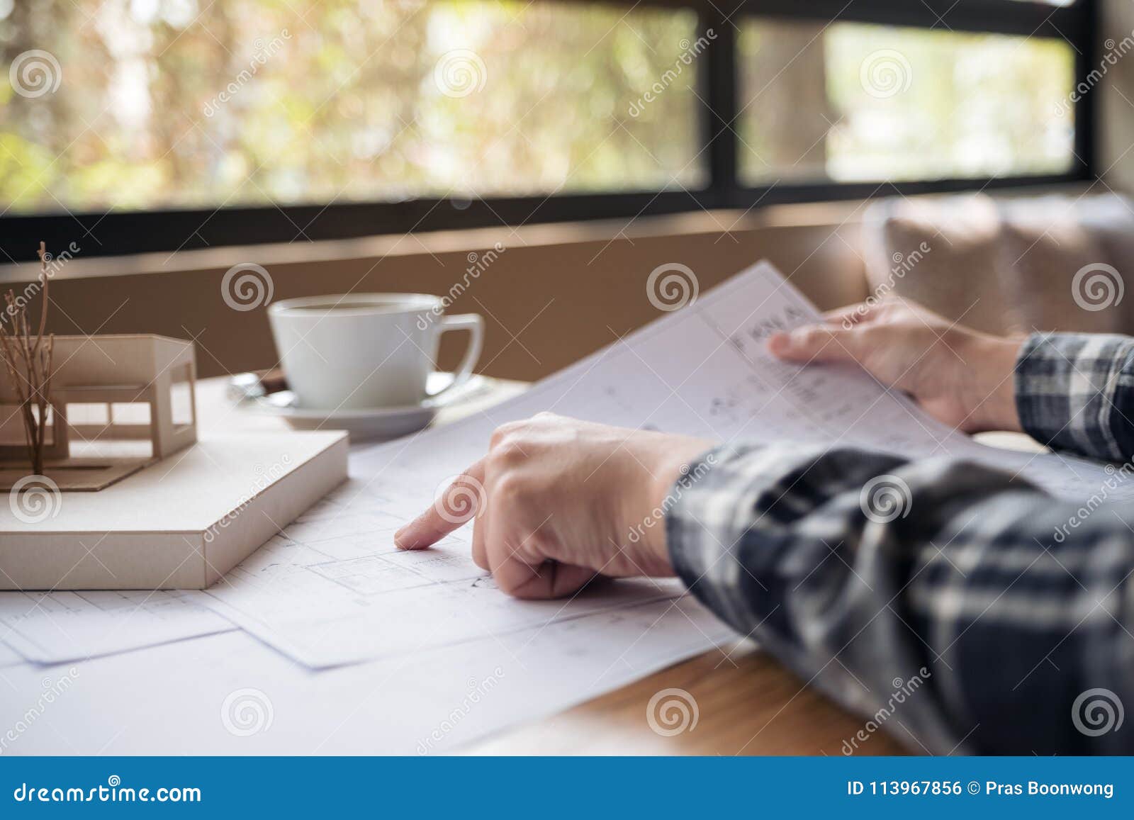 An Architect Working on an Architecture Model with Shop Drawing Paper ...
