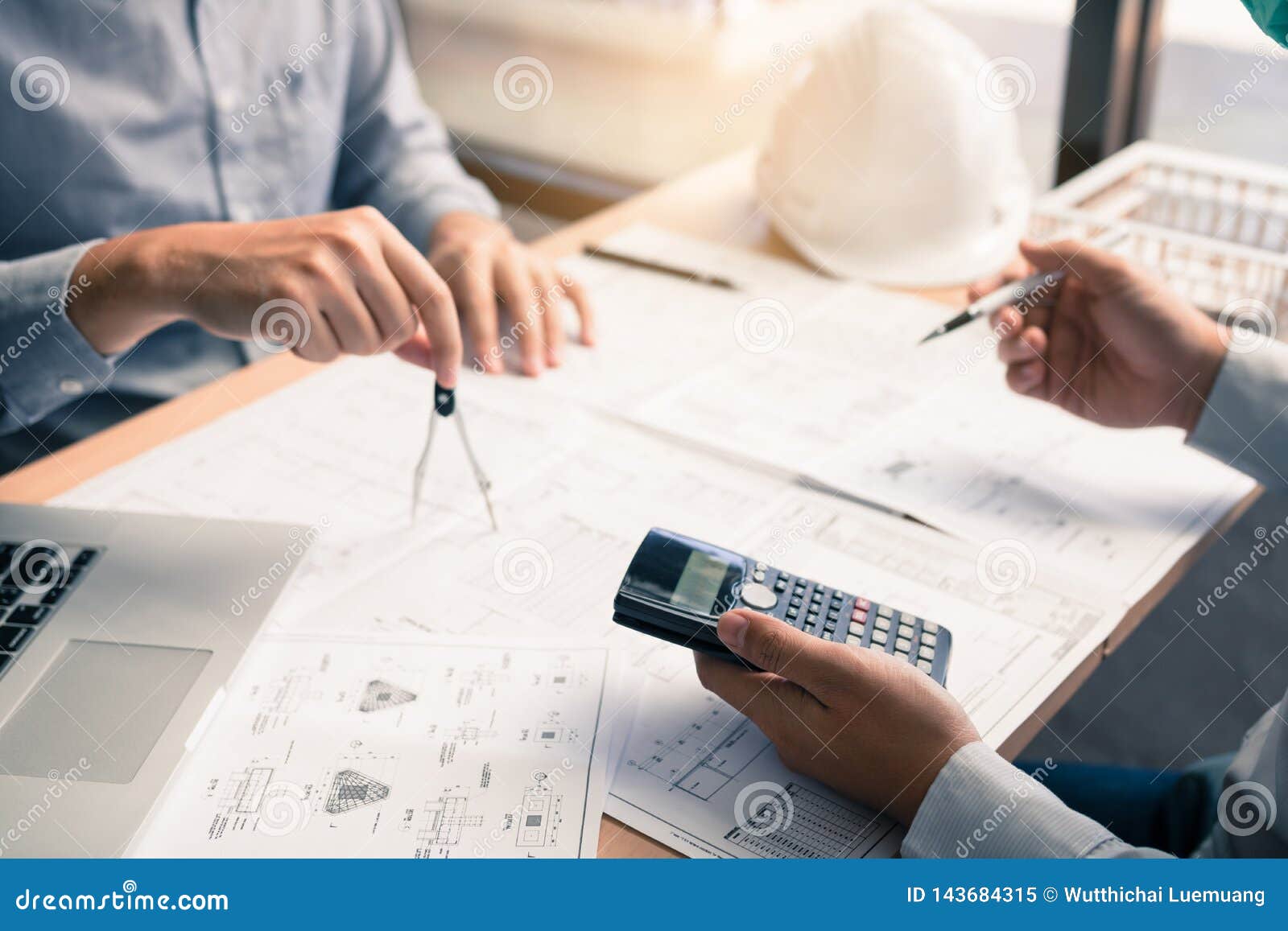 Architect Working on Blueprint in Workplace with Partnership and ...