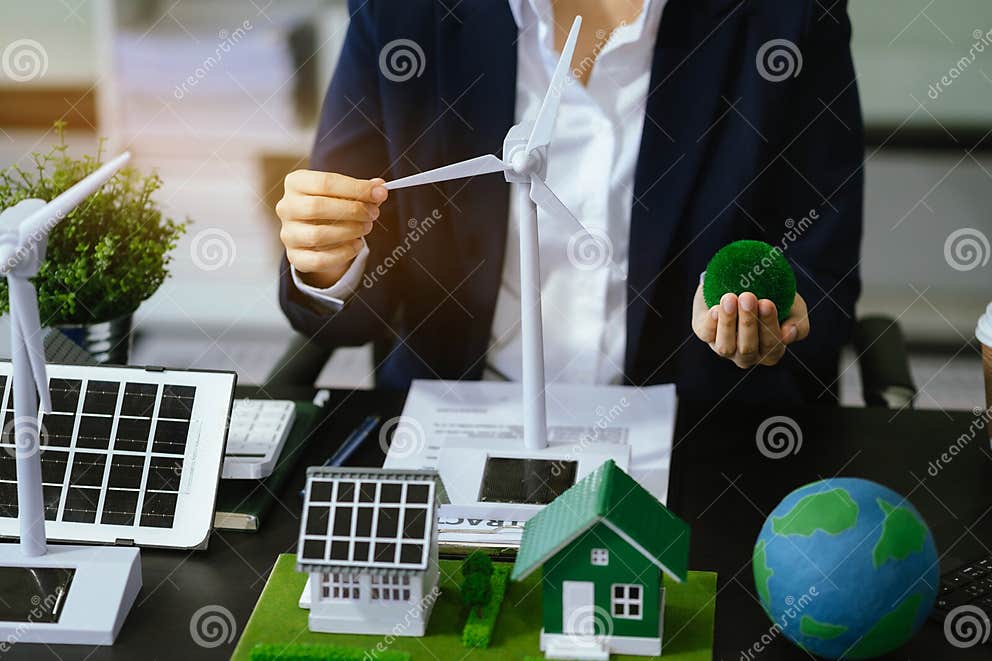 Architect Working with Blueprints for Sketching a Construction Project, Green Energy and Solar ...