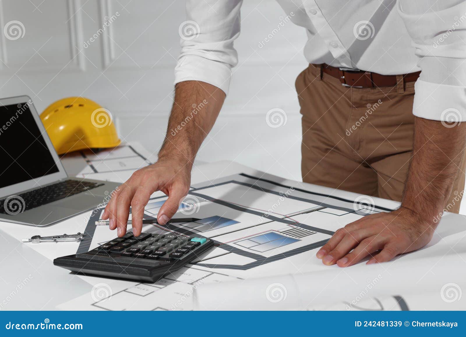 Architect Working with Construction Drawings and Calculator Indoors ...