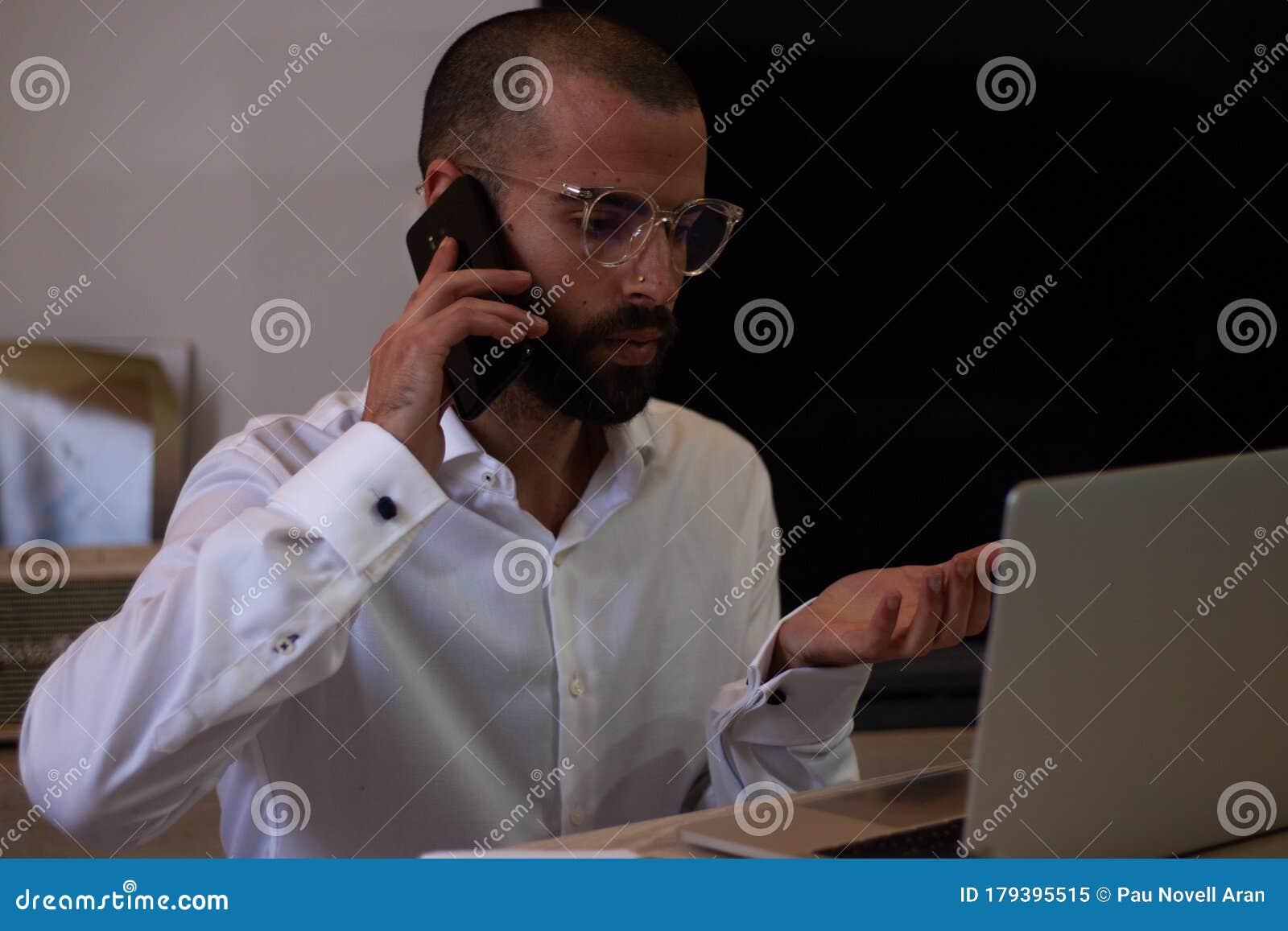 Architect Making a Call while Working with a Laptop at Home Stock Image ...