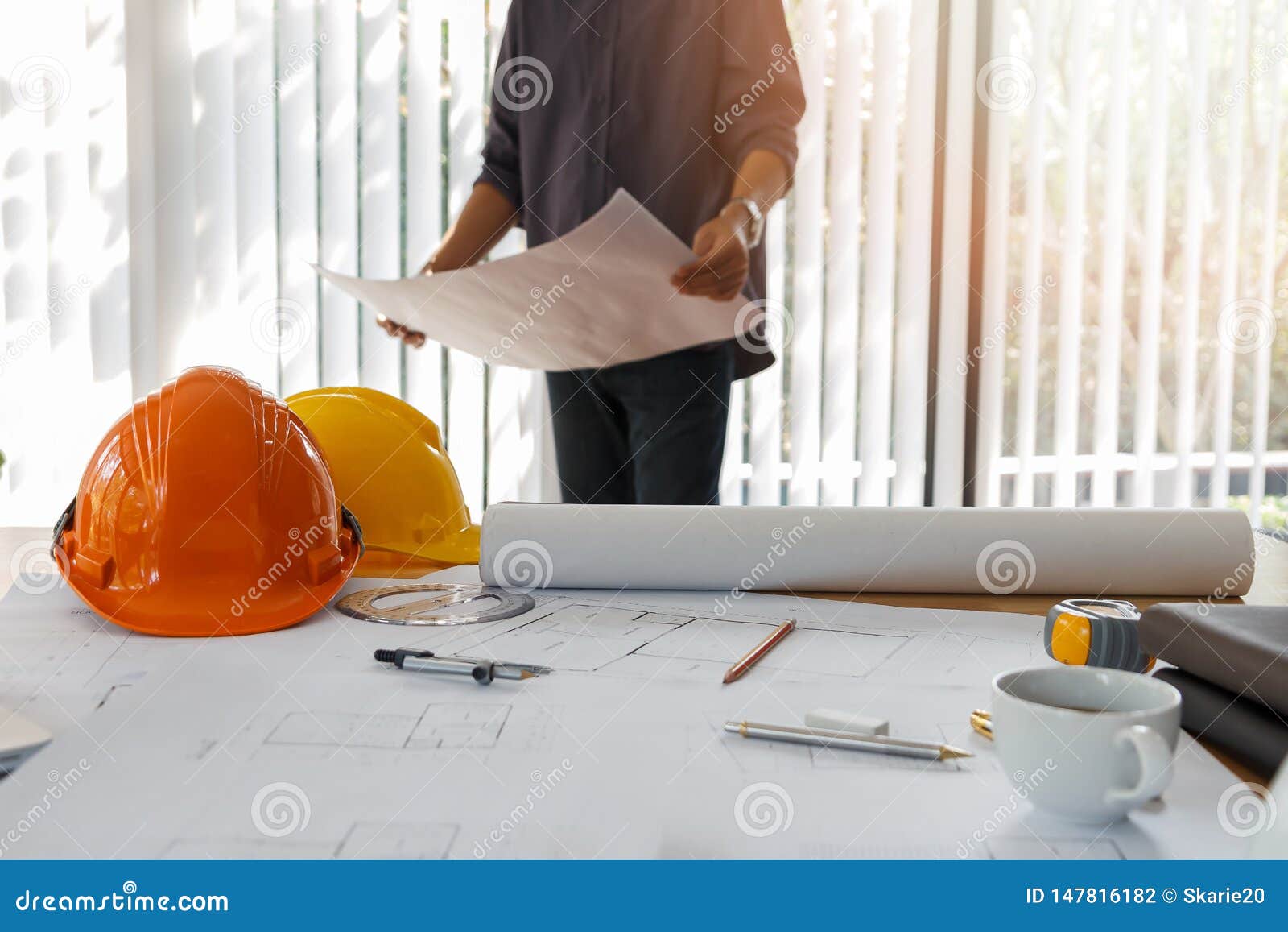 Architect Working in a Office. Engineer Holding Blueprint in Office ...