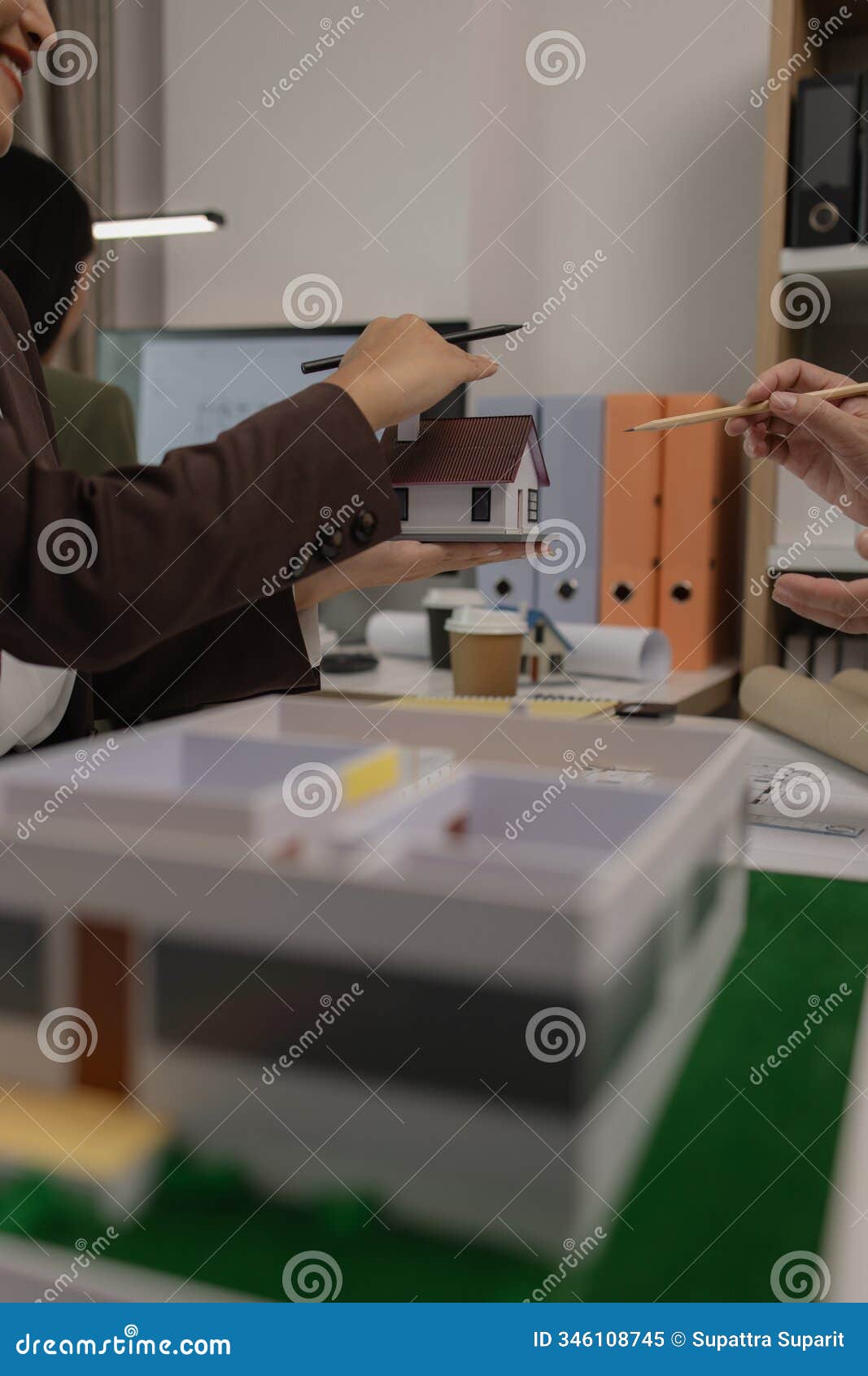 An Architect is Working in the Office with His Team, Blueprint on the ...