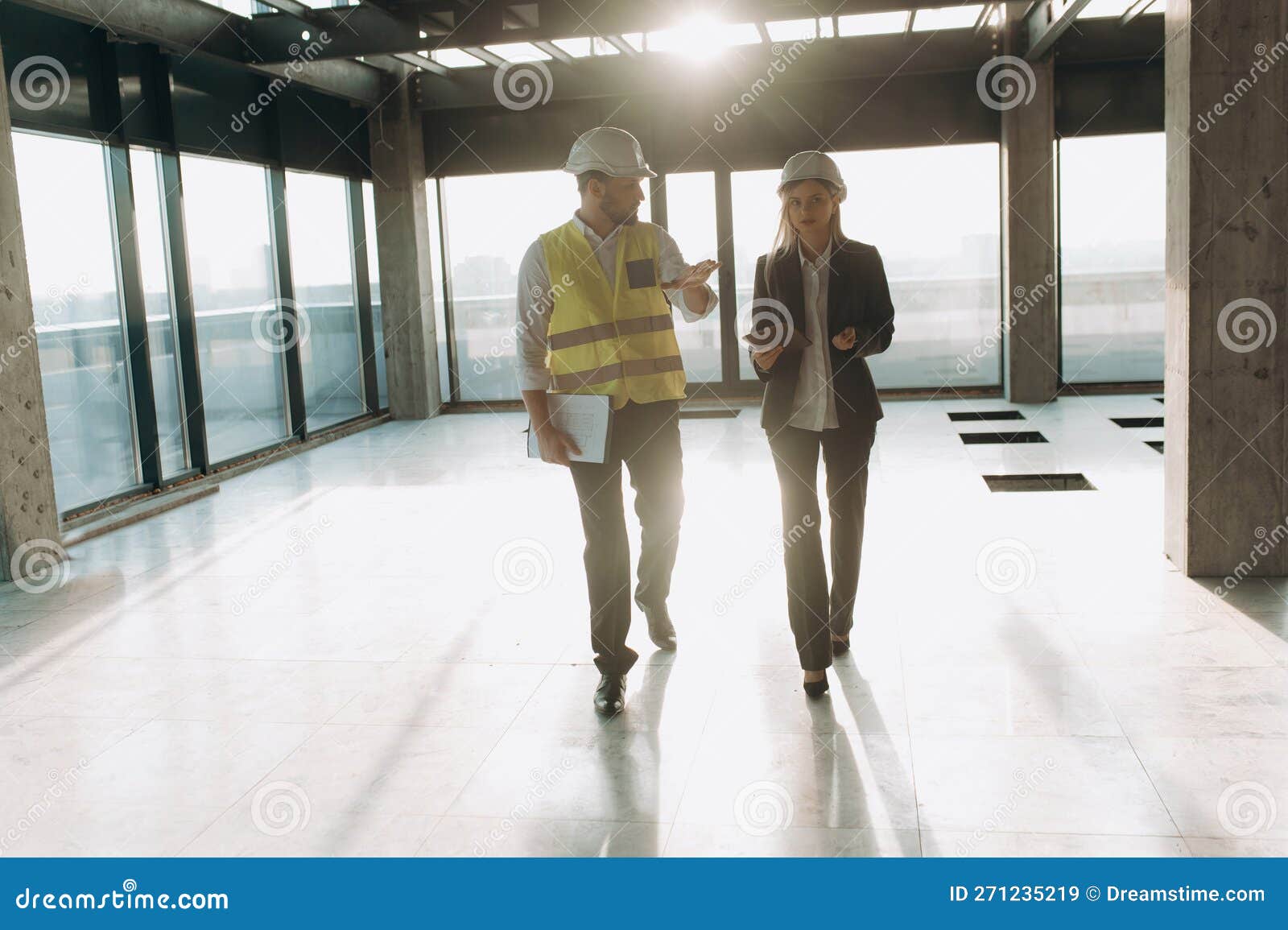 Architects on Construction. a Girl and a Male Engineer are Walking and ...