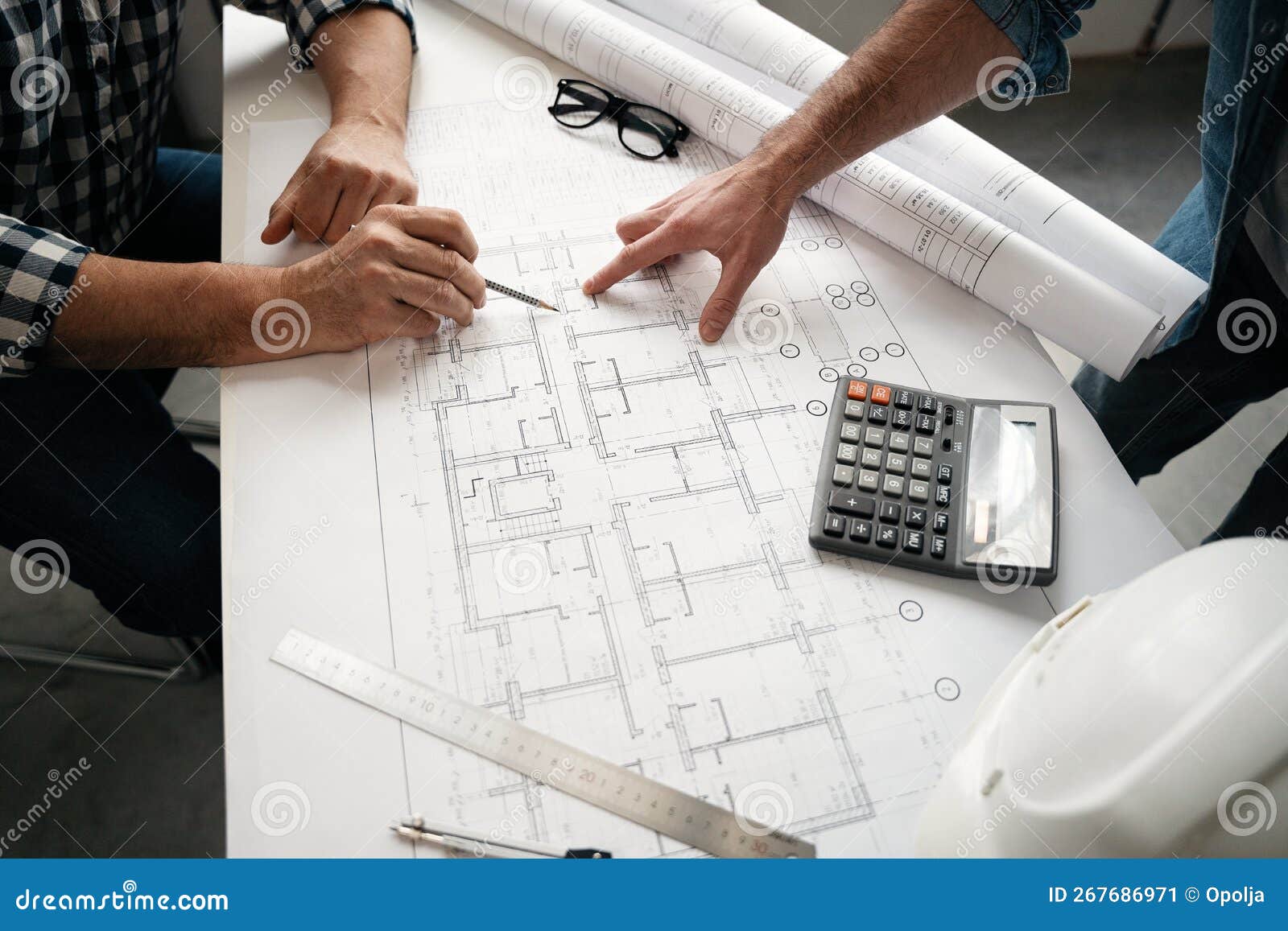 Architects Engineer Discussing at the Table with Blueprint - Closeup on ...