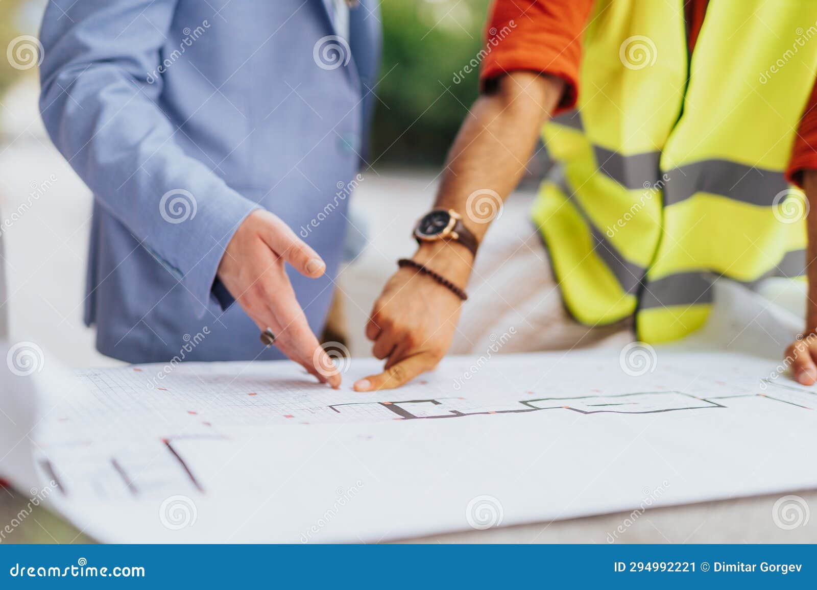 Architects, Engineers, and Designers Collaborate Outdoors, Reviewing ...