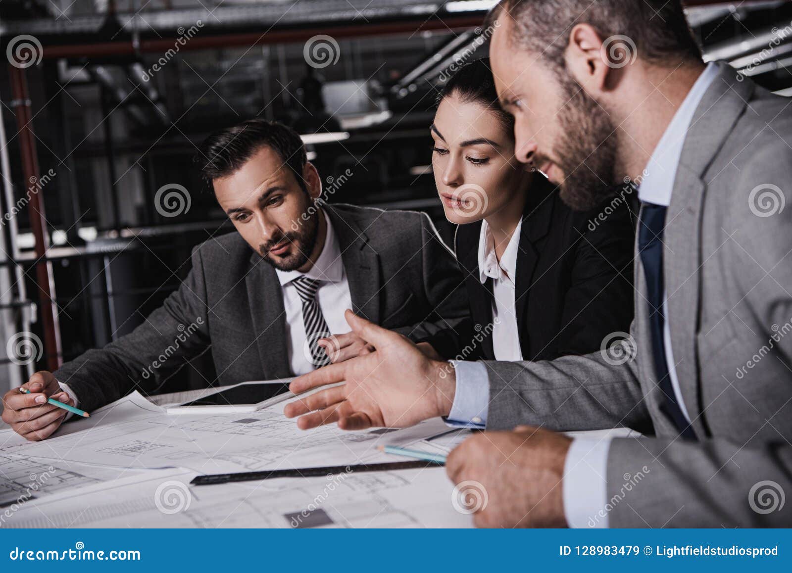 Architects and Engineers in Suits Working with Blueprints Together ...