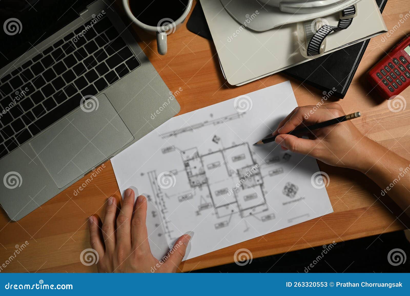Architects Man Working on Construction Plans and Using Laptop on Wooden ...