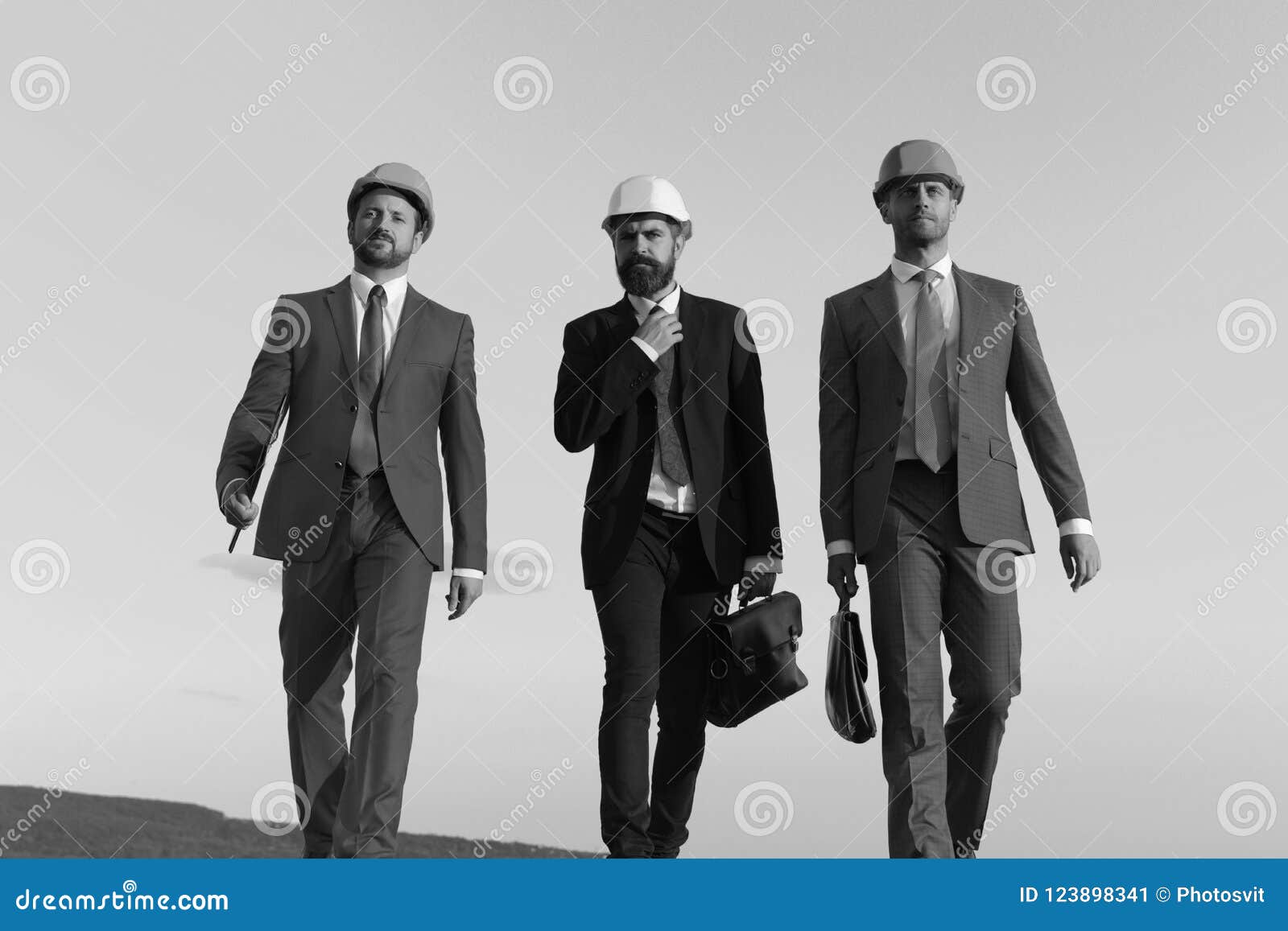 Architects with Strict Faces in Suits, White and Orange Helmets Stock ...